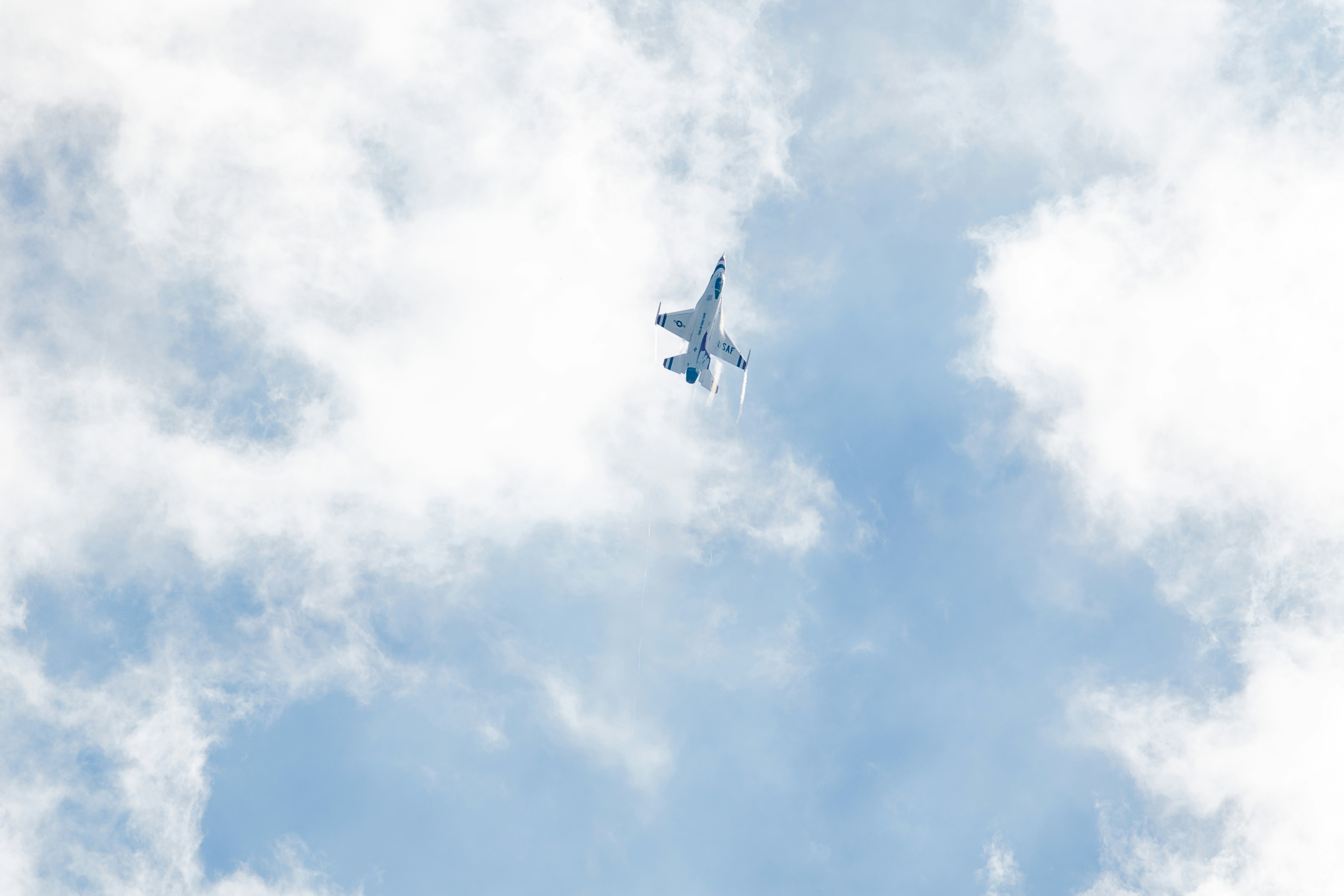 Thunderbirds | A jet plane soars through cloudy skies.