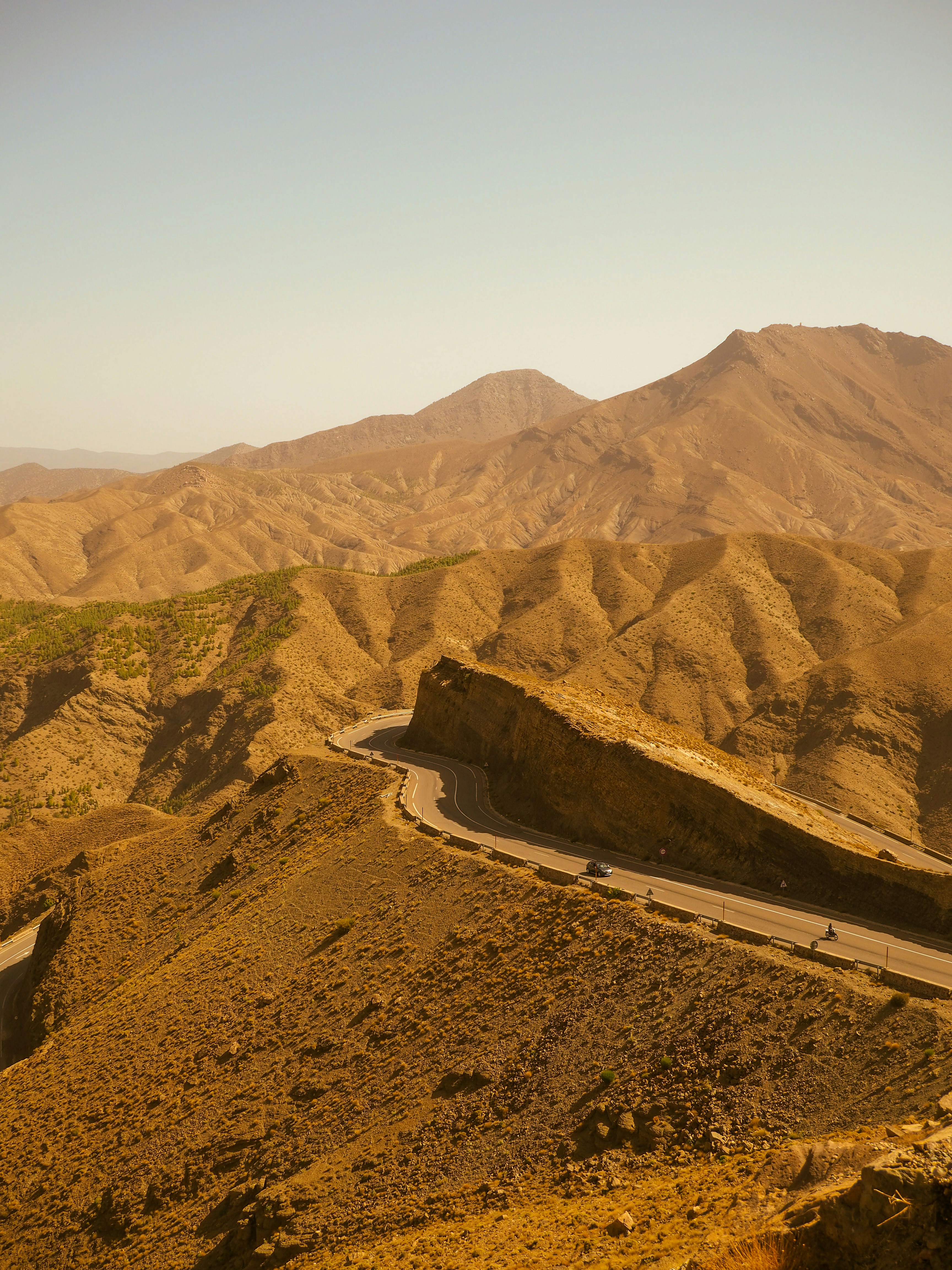 OLYMPUS DIGITAL CAMERA | A winding road through a vast mountain landscape.