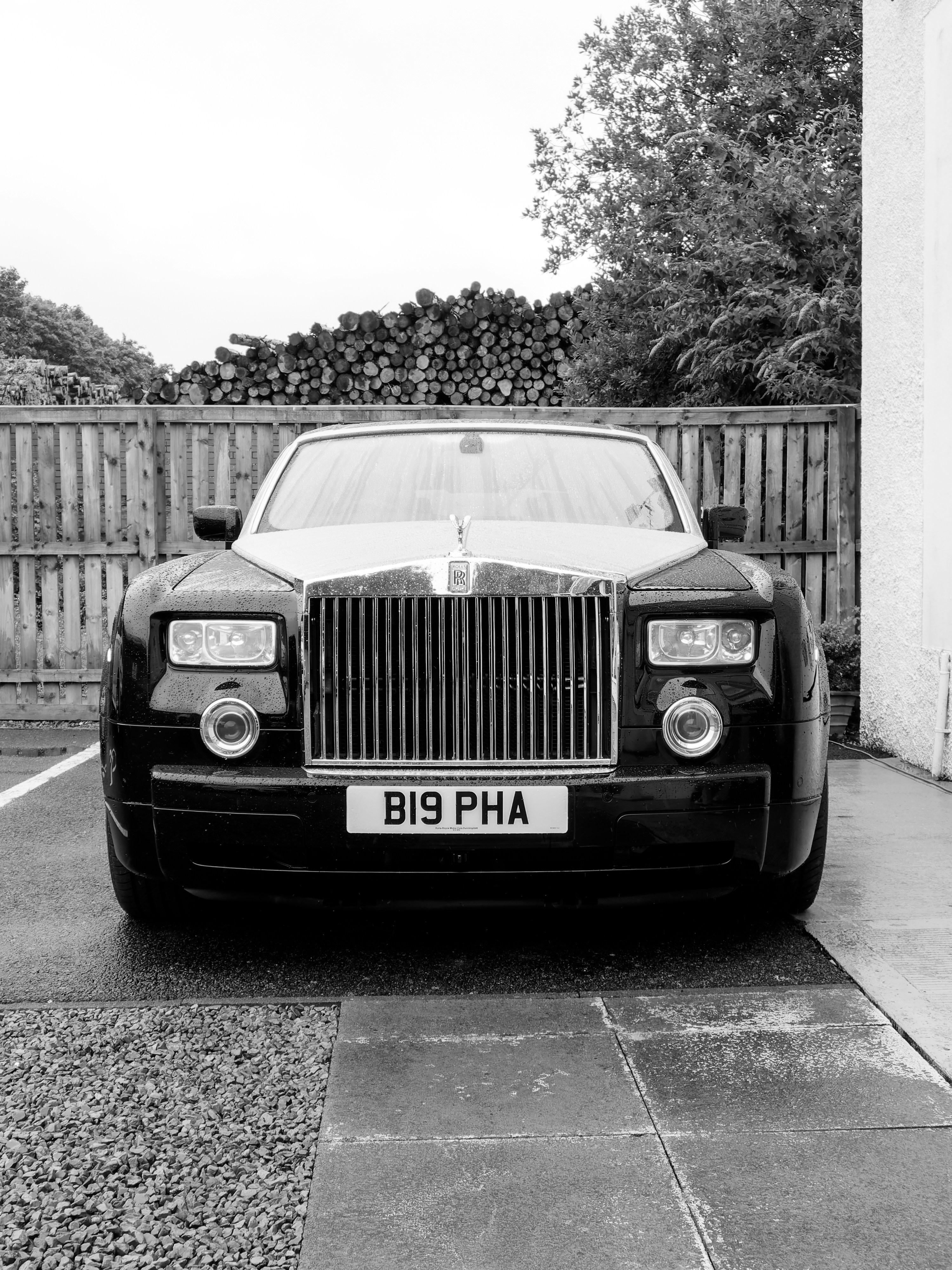 Rolls-Royce Phantom VII. | A black rolls royce parked in front of a house.