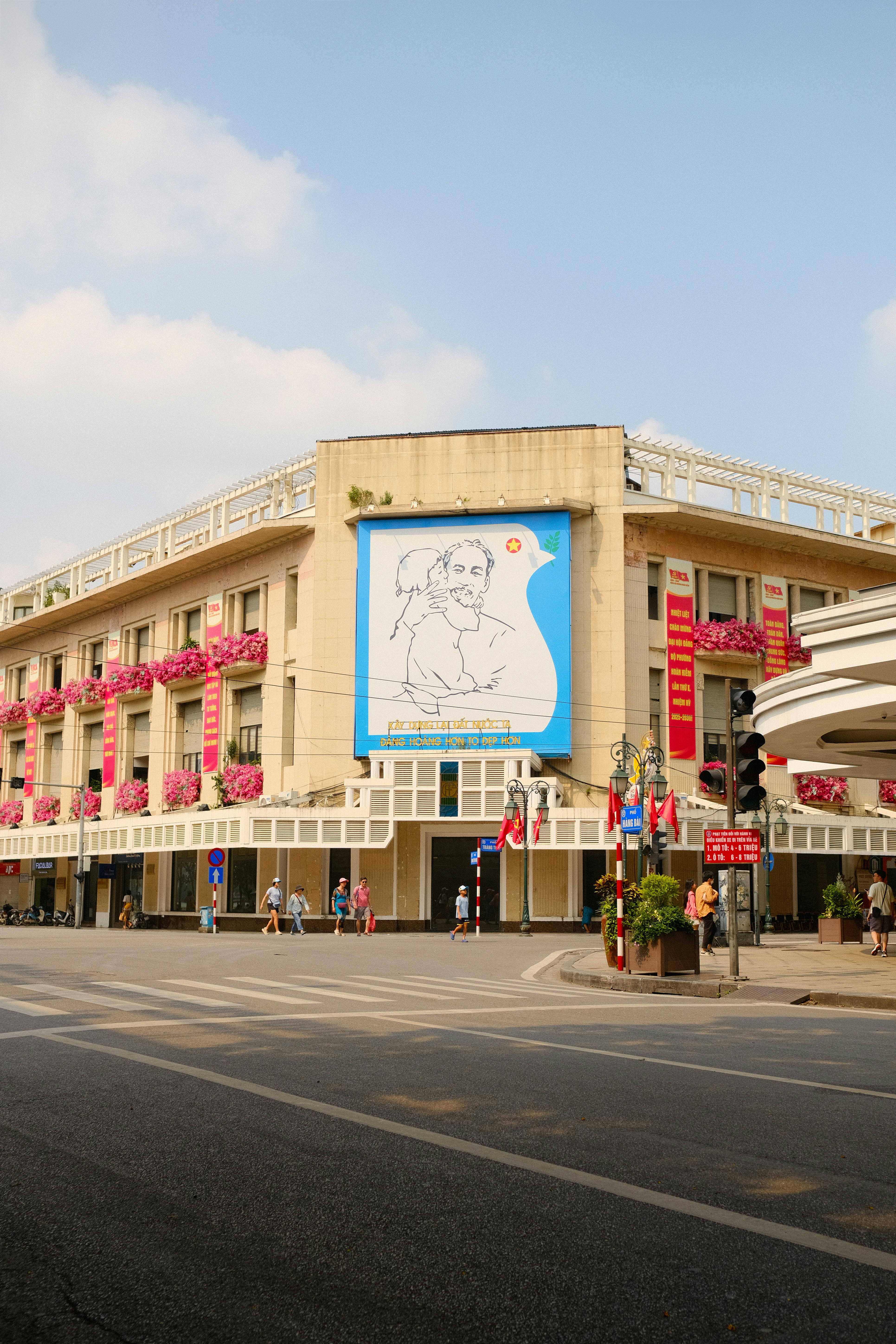 Building with a portrait on its side, a crosswalk.