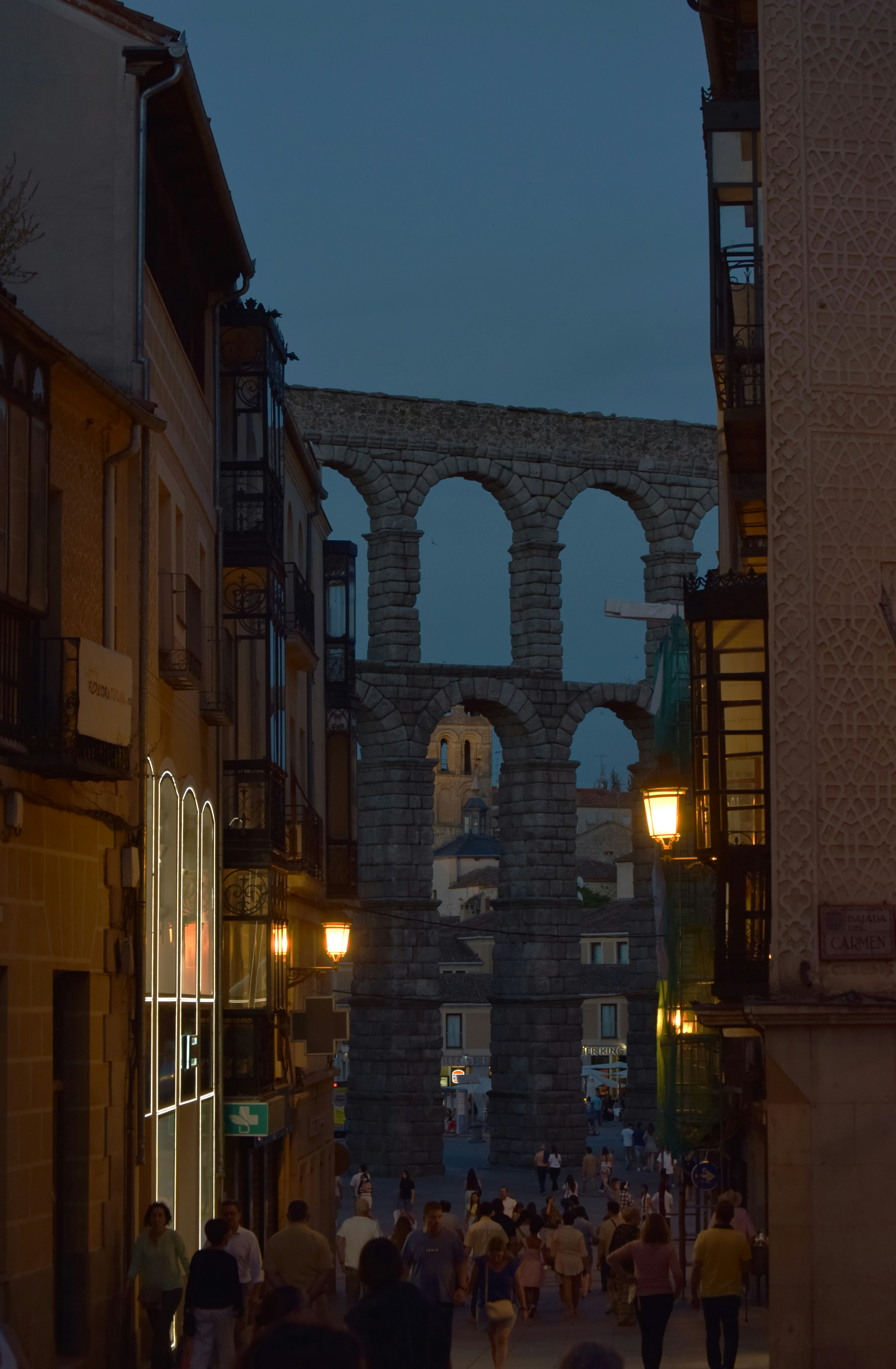 A view of the aqueduct in segovia at dusk.