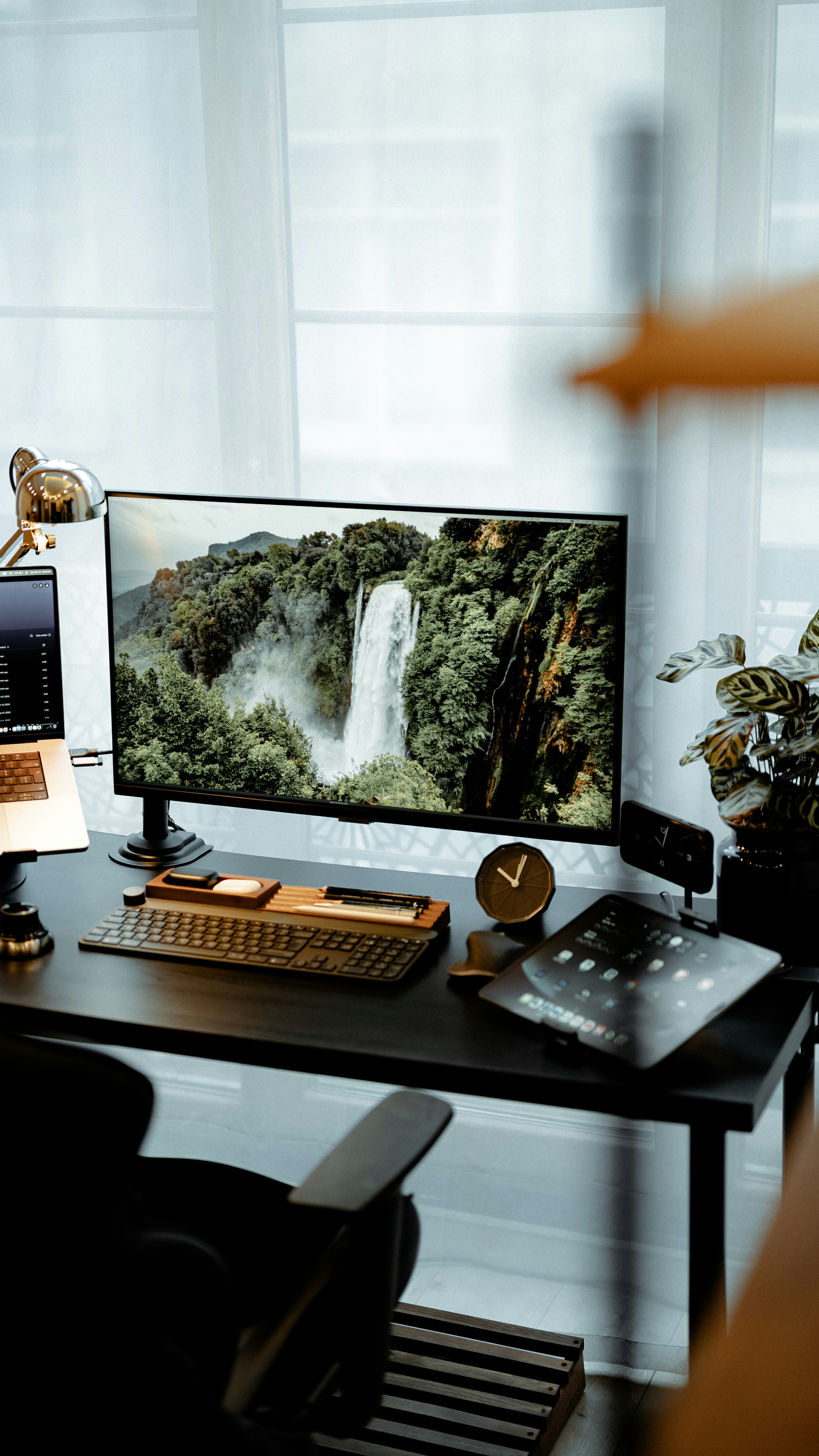 As a 3D artist and designer, I sometimes find myself drawn to photography and living in Istanbul, with all its beauty, has turned that impulse into something truly special. I don’t consider myself a photographer, but I do allow myself to press the shutter when it feels like the right moment to capture something. Sometimes it’s a fleeting scene on the street, something that only asks for my presence and attention. Other times, it’s an image I’ve carefully constructed with intention and patience. | Modern desk with waterfall wallpaper and accessories.