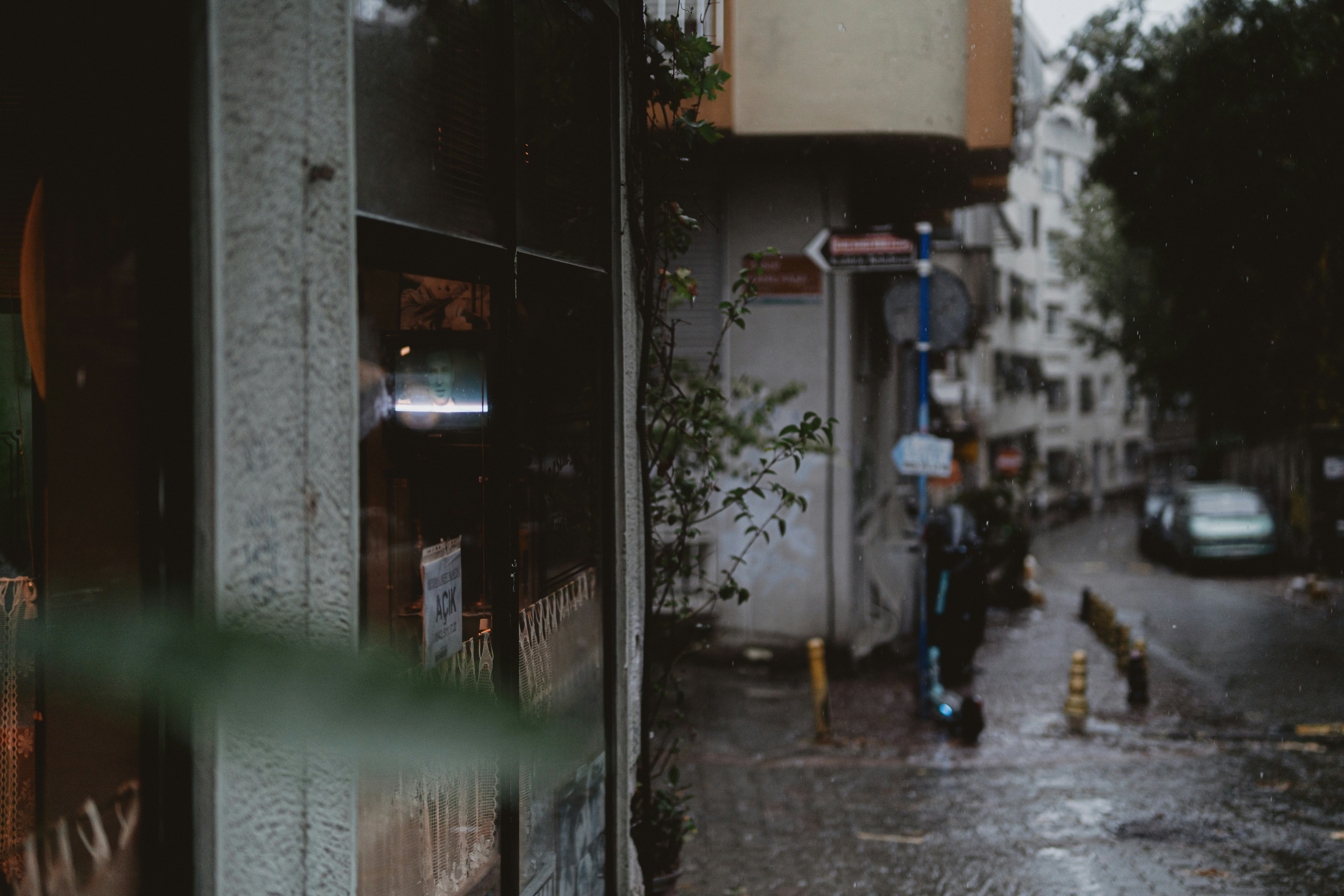 As a 3D artist and designer, I sometimes find myself drawn to photography and living in Istanbul, with all its beauty, has turned that impulse into something truly special. I don’t consider myself a photographer, but I do allow myself to press the shutter when it feels like the right moment to capture something. Sometimes it’s a fleeting scene on the street, something that only asks for my presence and attention. Other times, it’s an image I’ve carefully constructed with intention and patience. | Rainy street scene with buildings and a car.