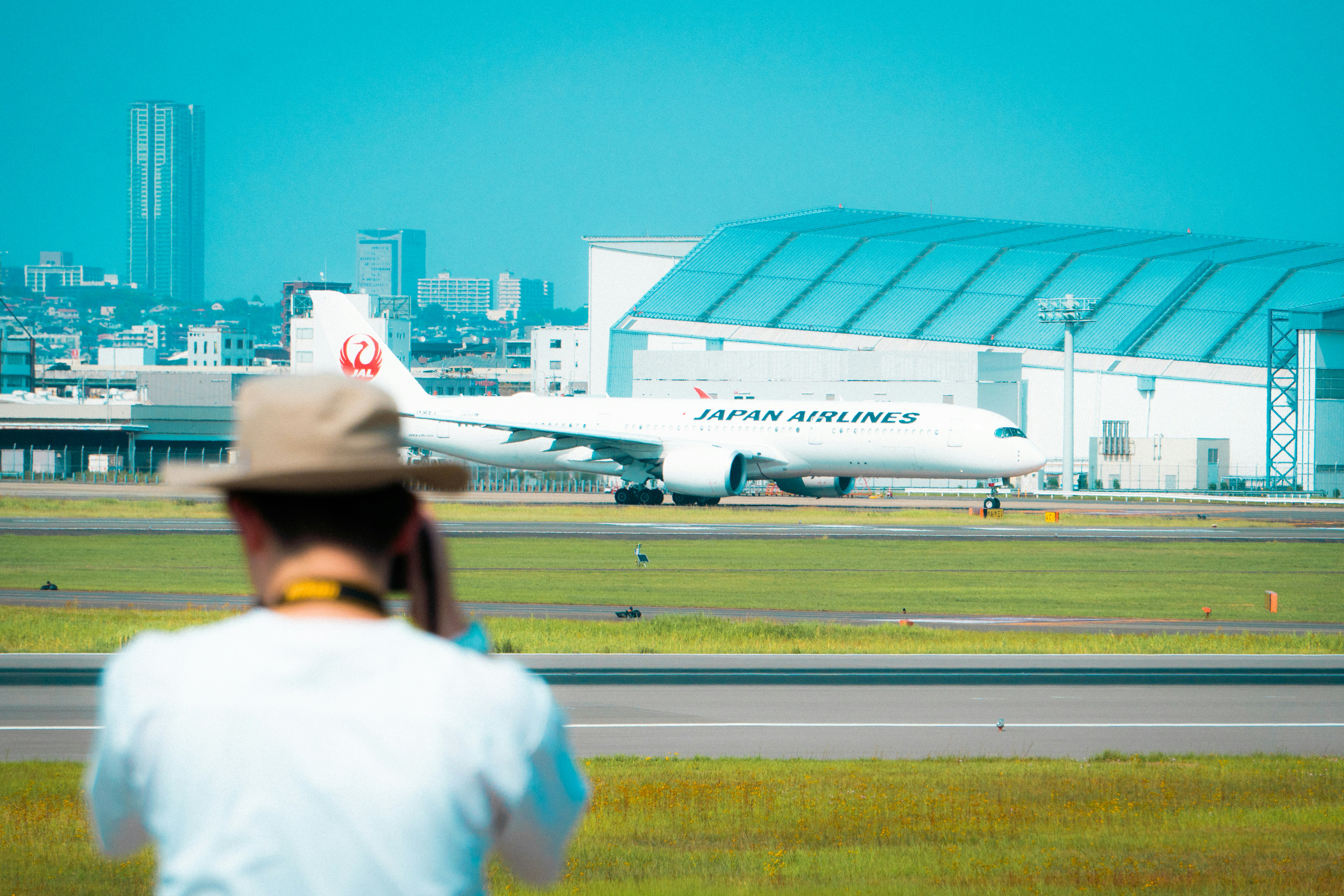 Photographer captures a japan airlines plane on tarmac.