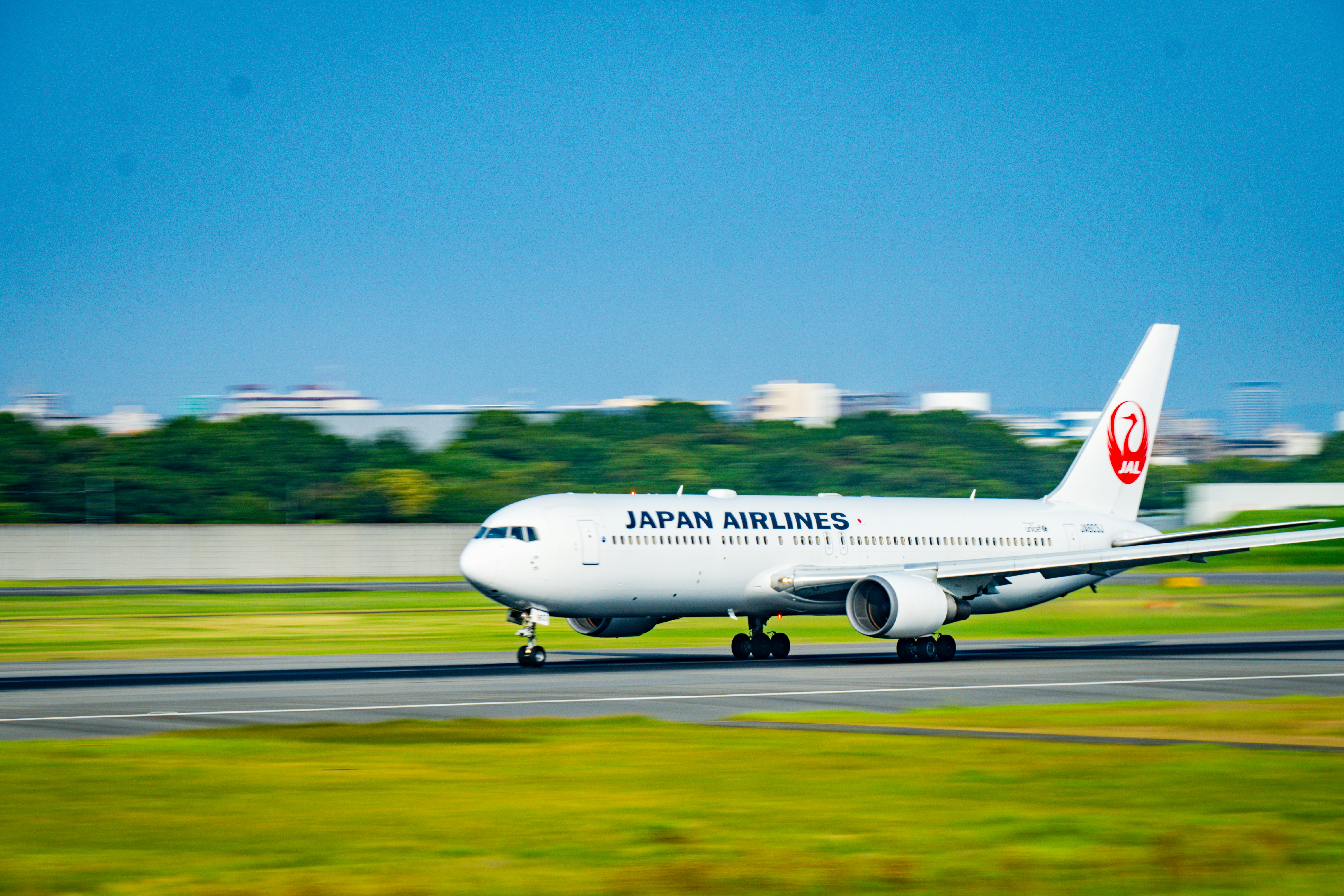 A japan airlines plane is landing on the runway. photo – Free Airplane ...