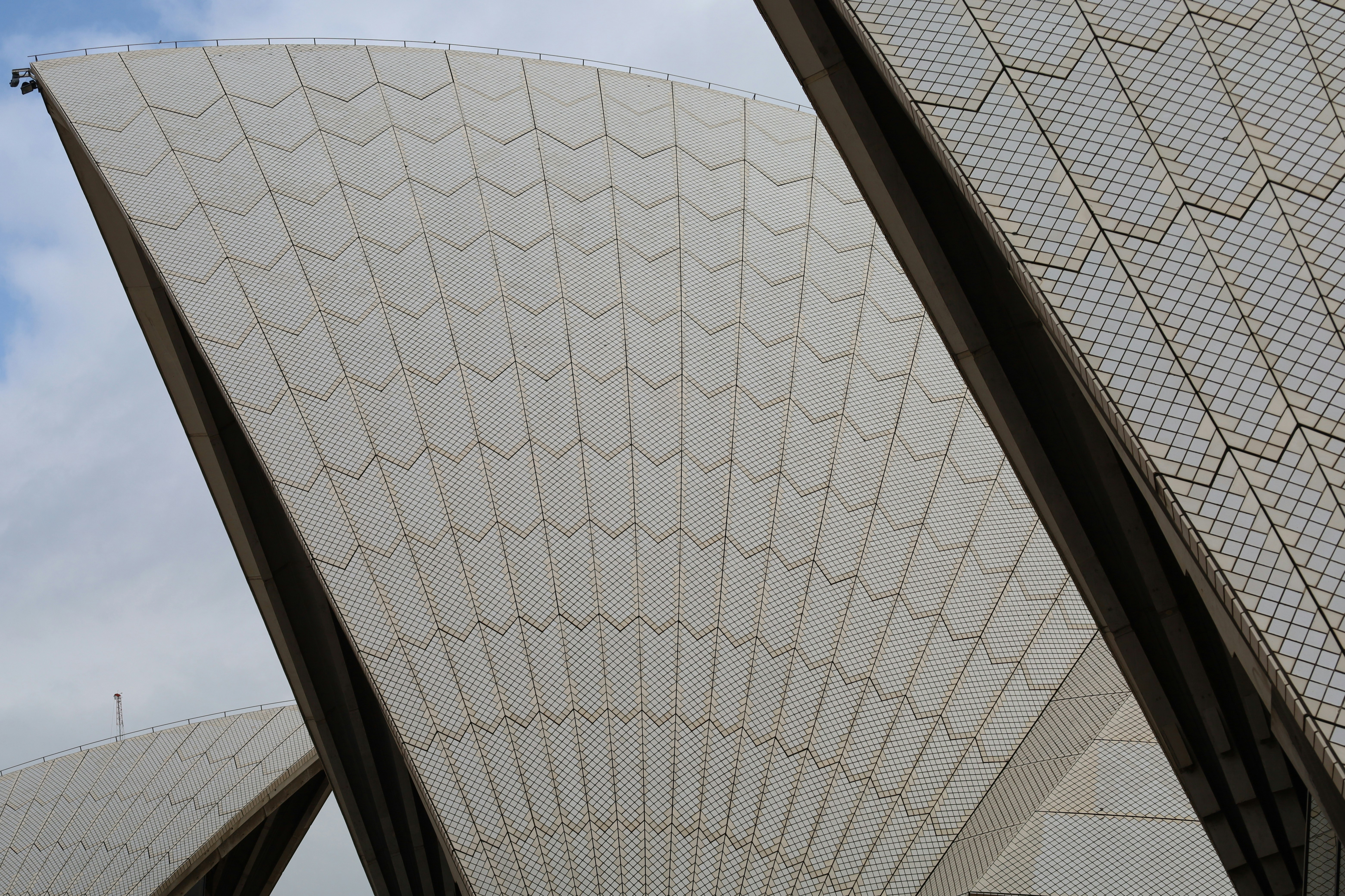 The sydney opera house's distinctive roof is shown.