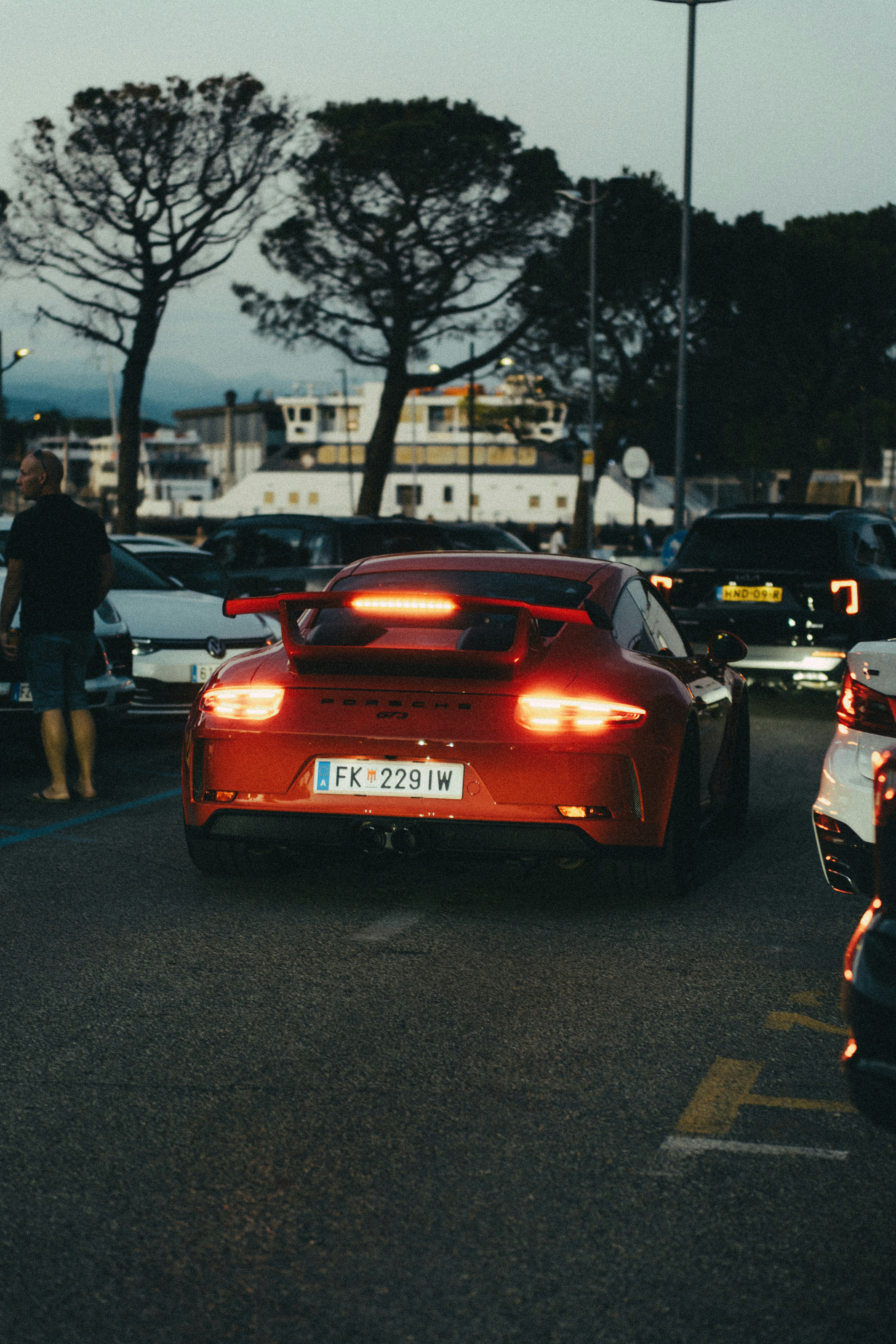 A red porsche 911 is parked.
