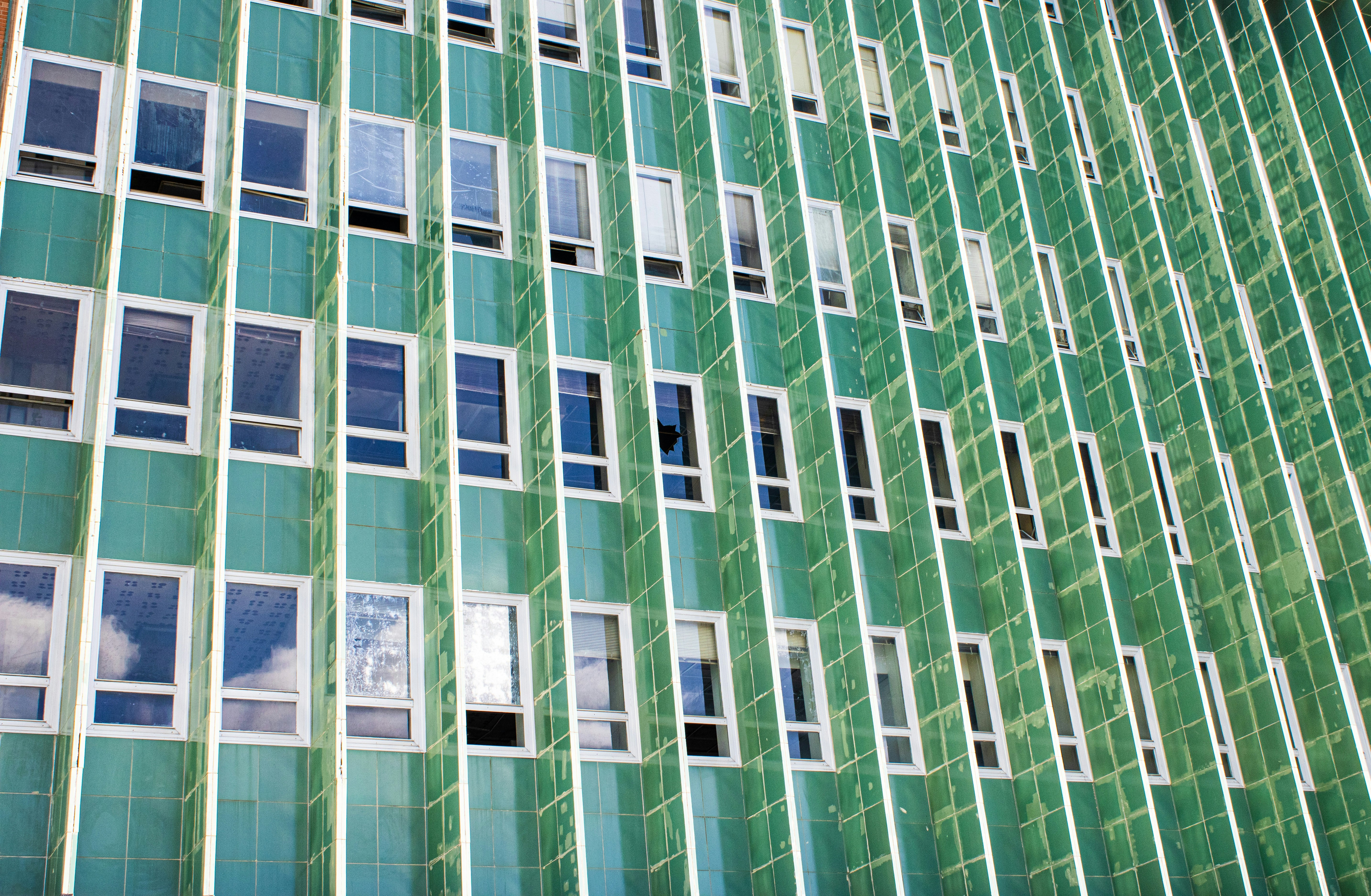 Downtown Corsicana, TX building. | Green building facade with many symmetrical windows.