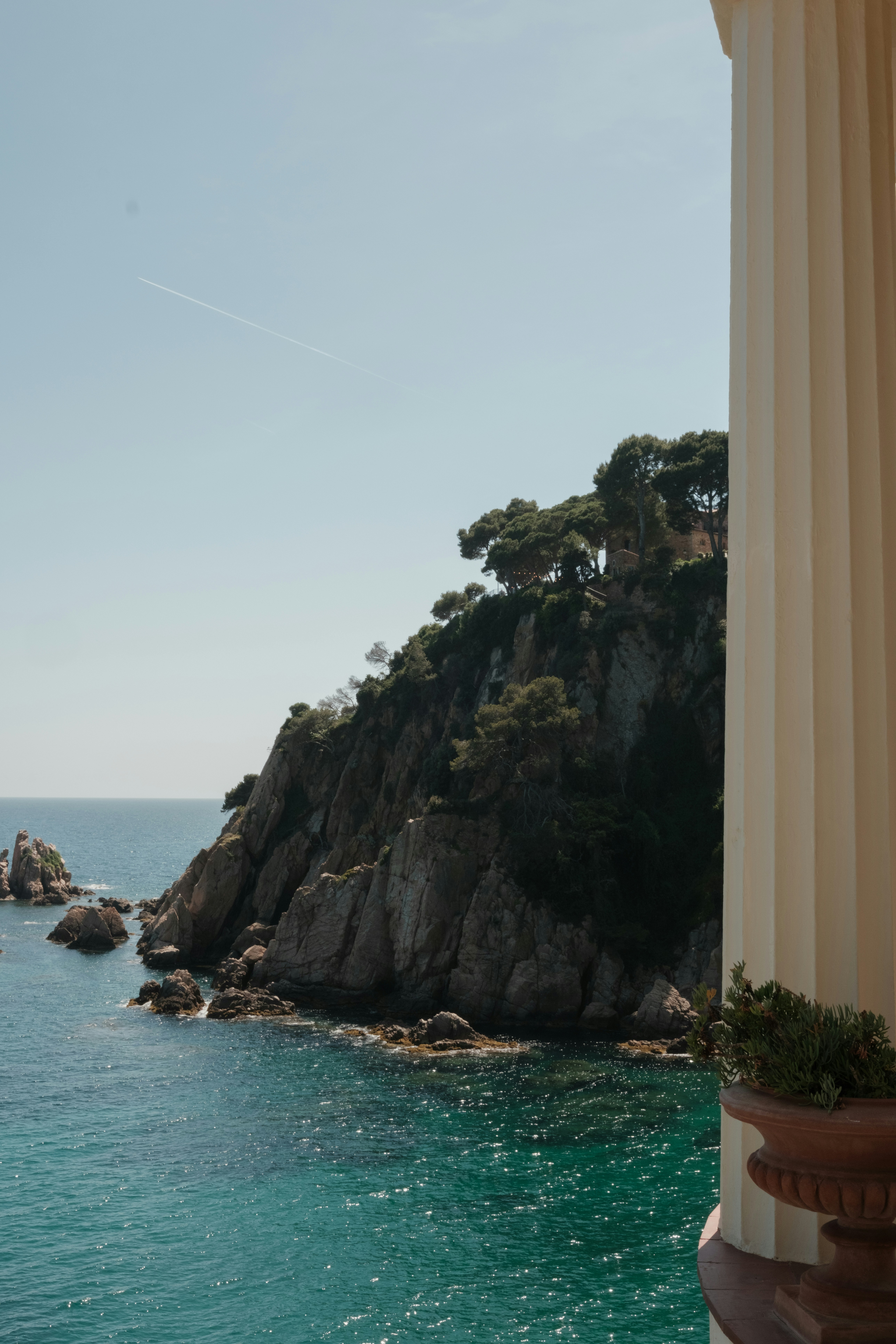 Ocean view with cliff and clear sky.