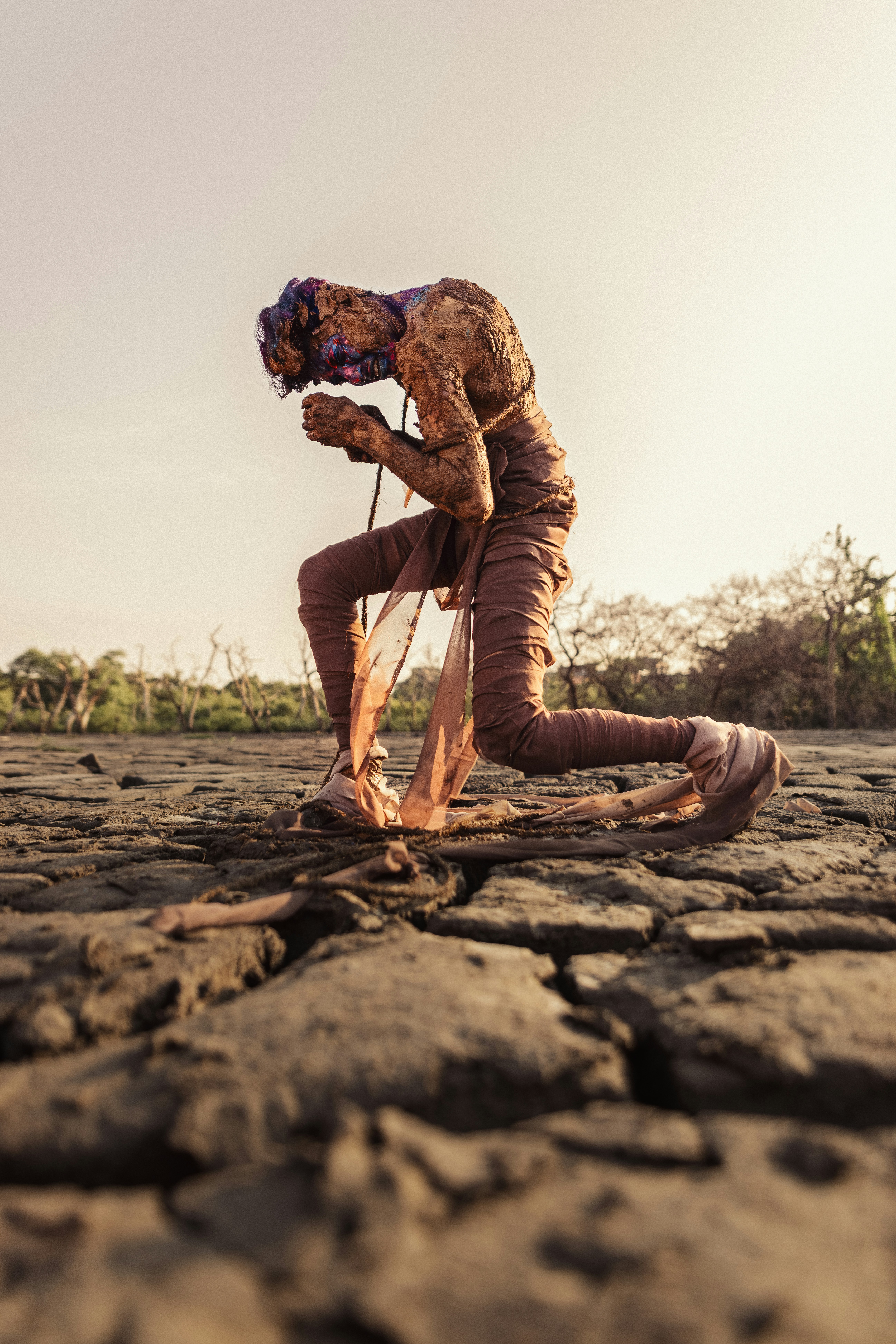 Parched Crust, Mud-Wrapped Dancer: A Golden Hour Ritual on Cracked Earth