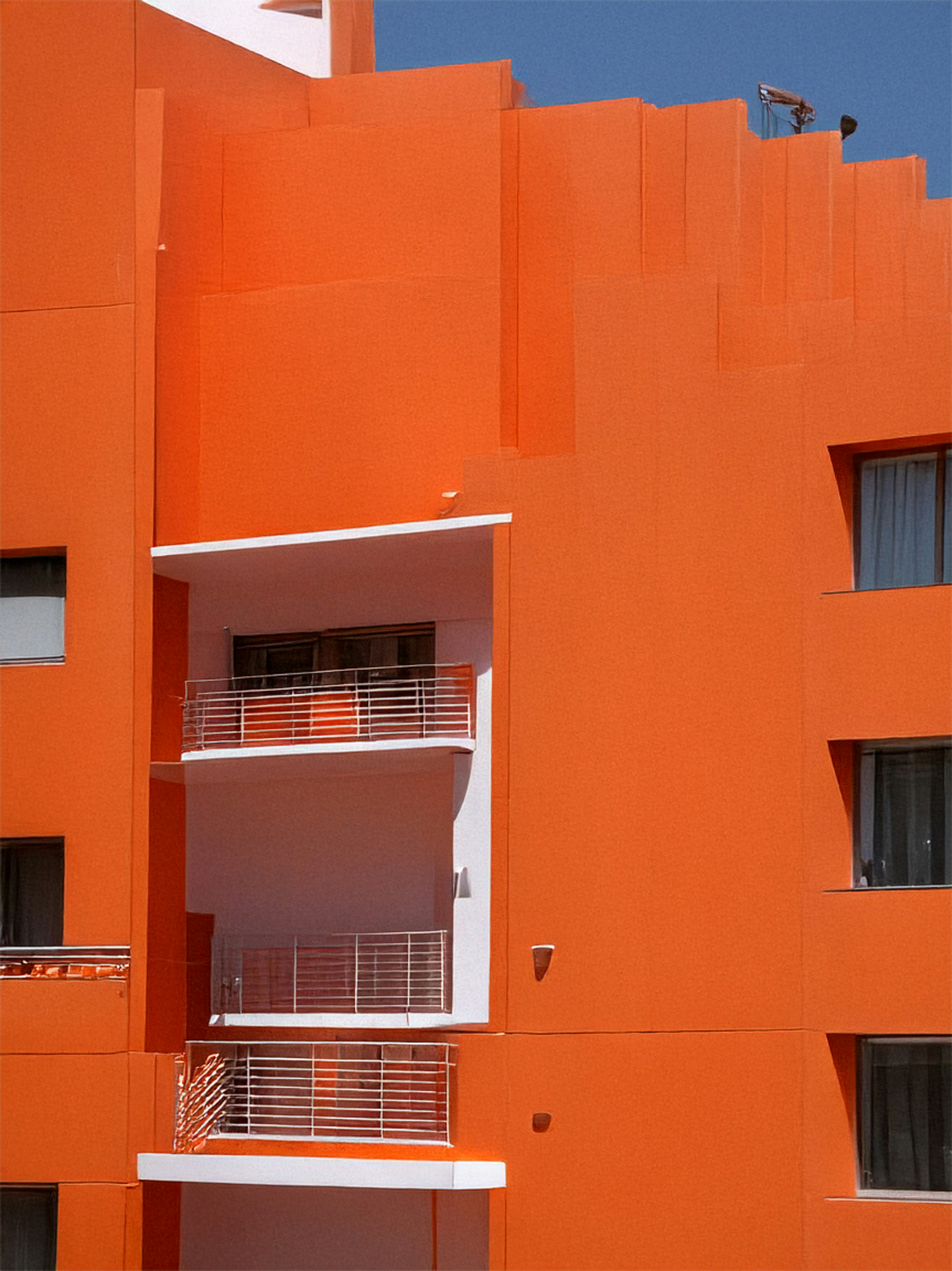 Bright orange building with white balconies and windows. photo – Free ...