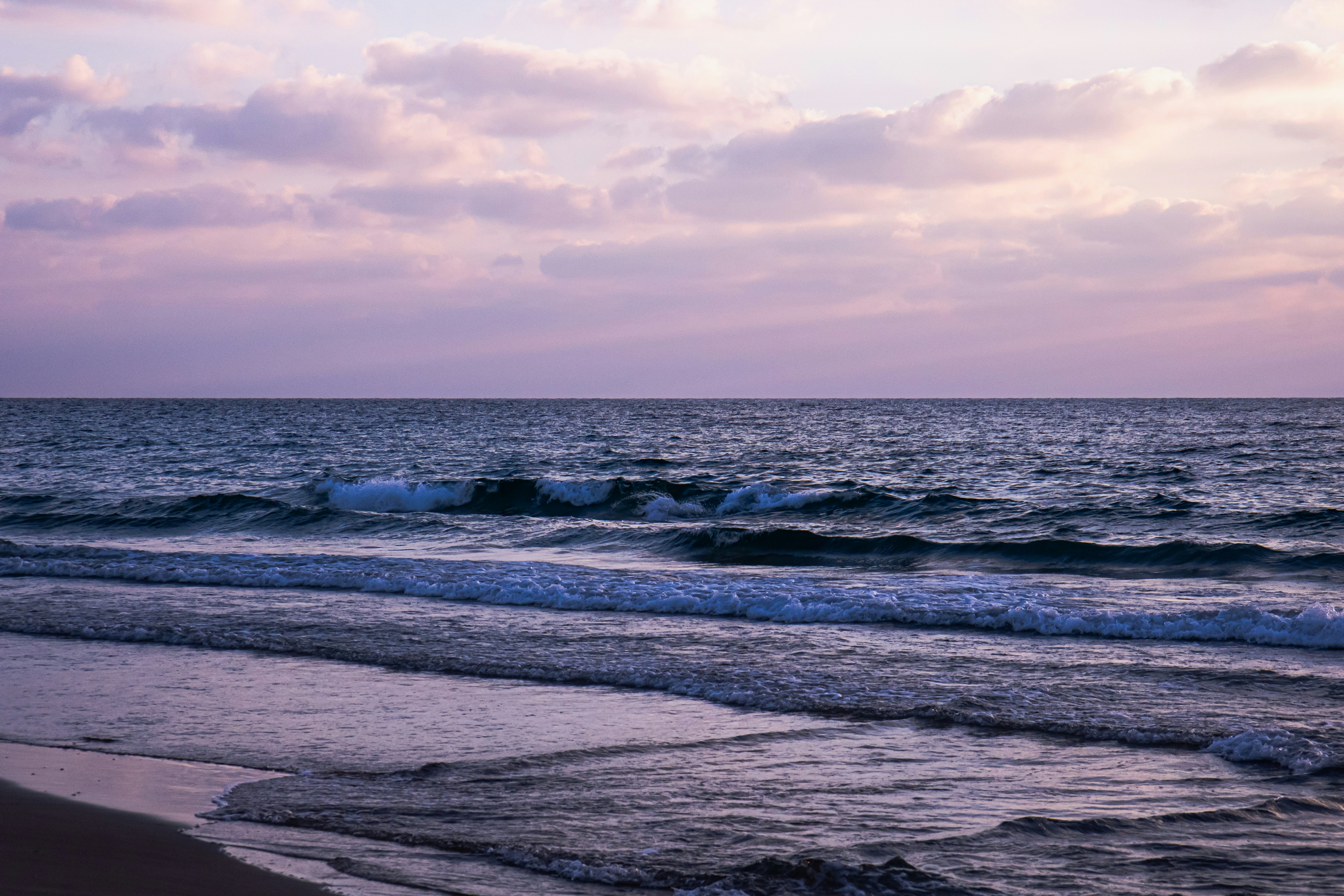 Waves gently roll onto the beach at sunset. photo – Free Dramatic sky ...