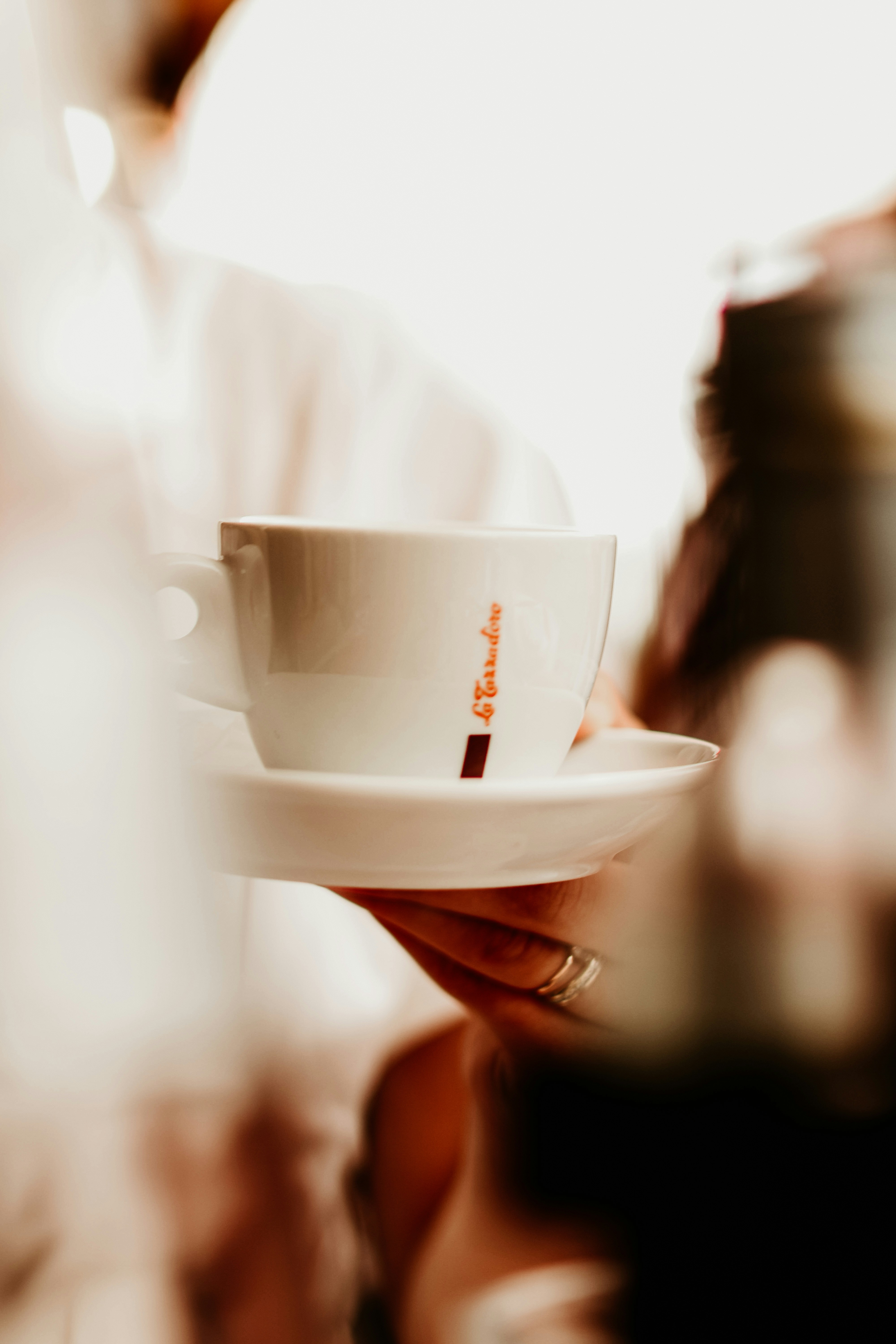 Someone is serving a cup of coffee.