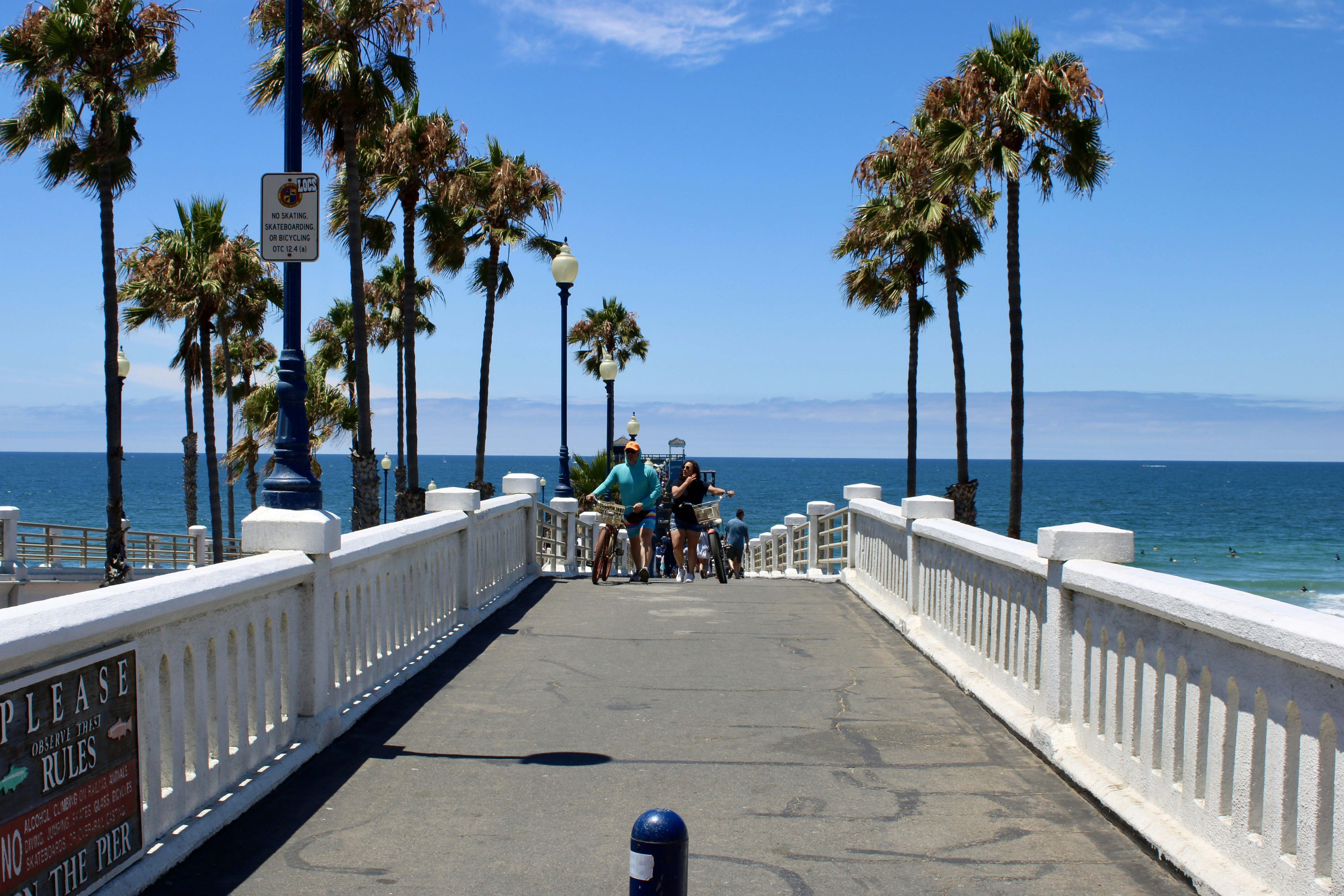 People are riding bicycles on a pier.