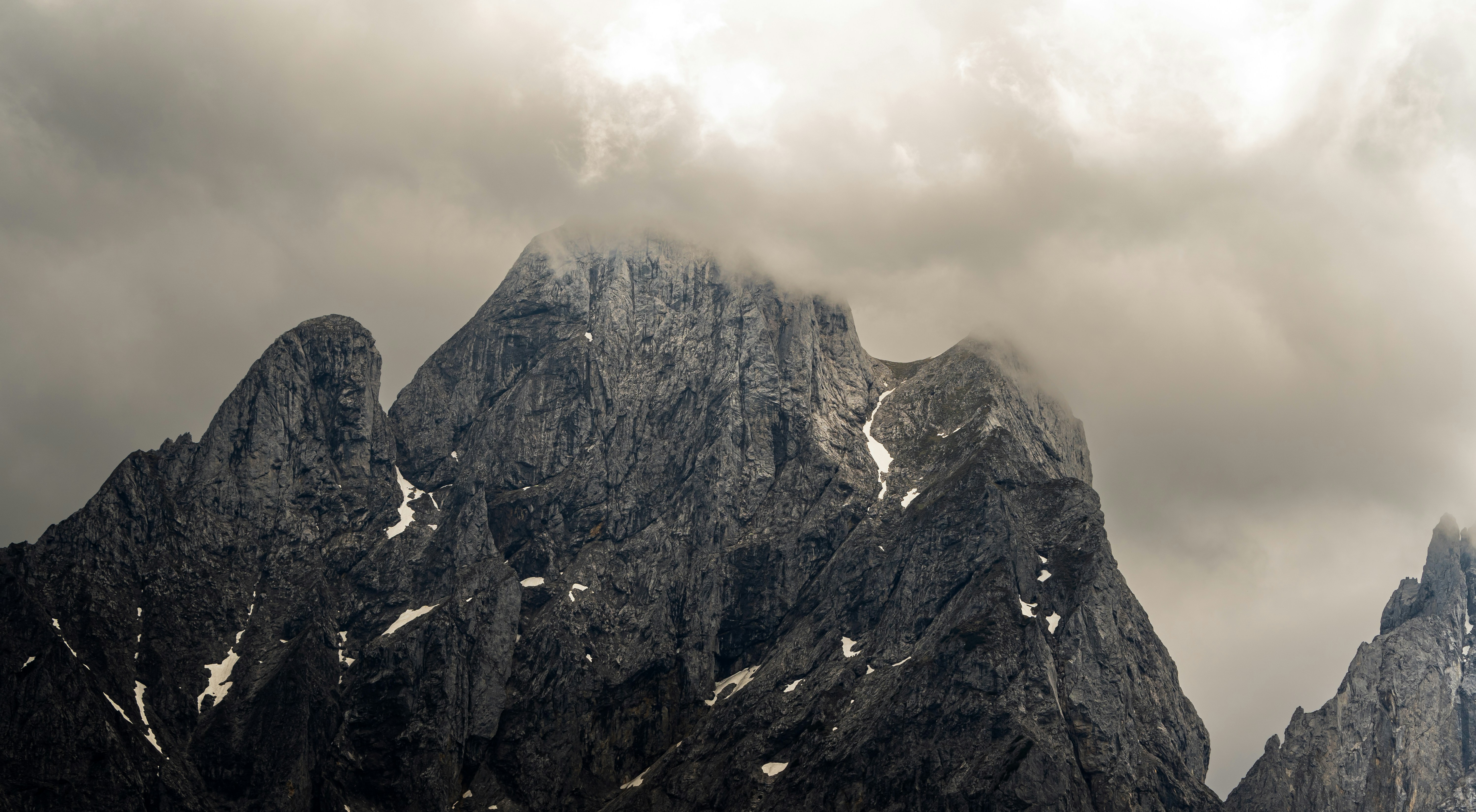 Rocky mountain peaks shrouded by clouds.