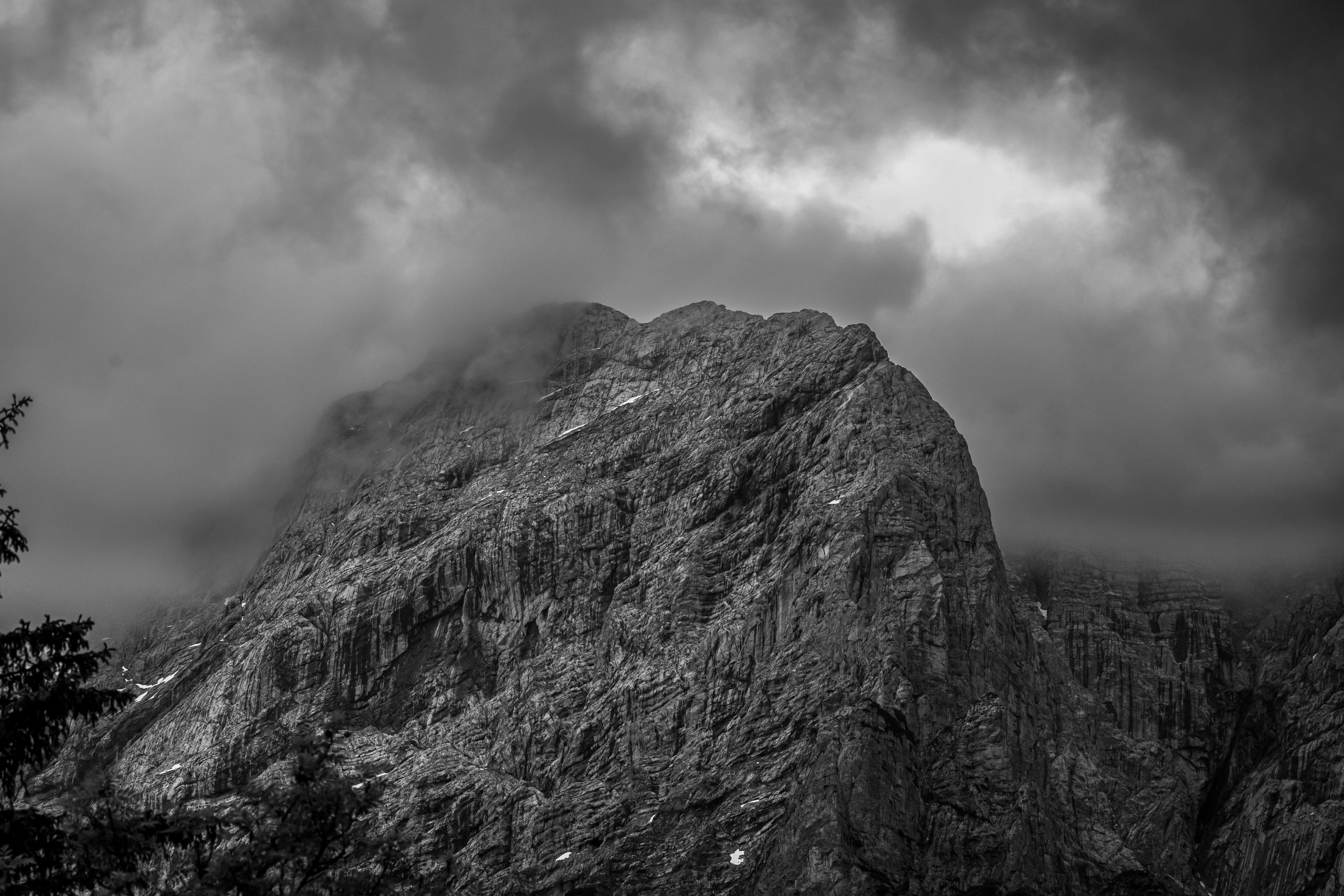 A mountain is obscured by cloudy skies.