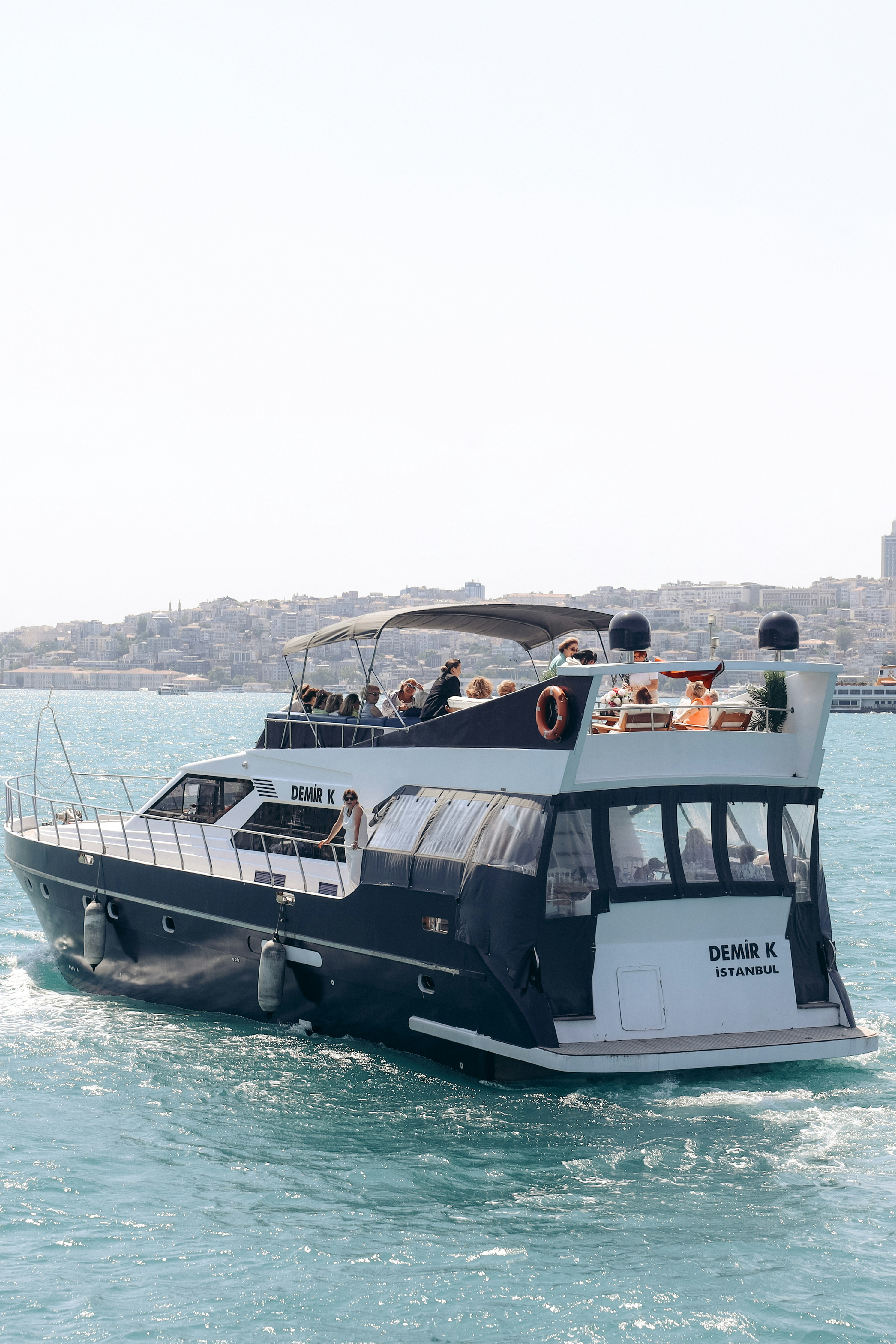 A boat with passengers sails on water.