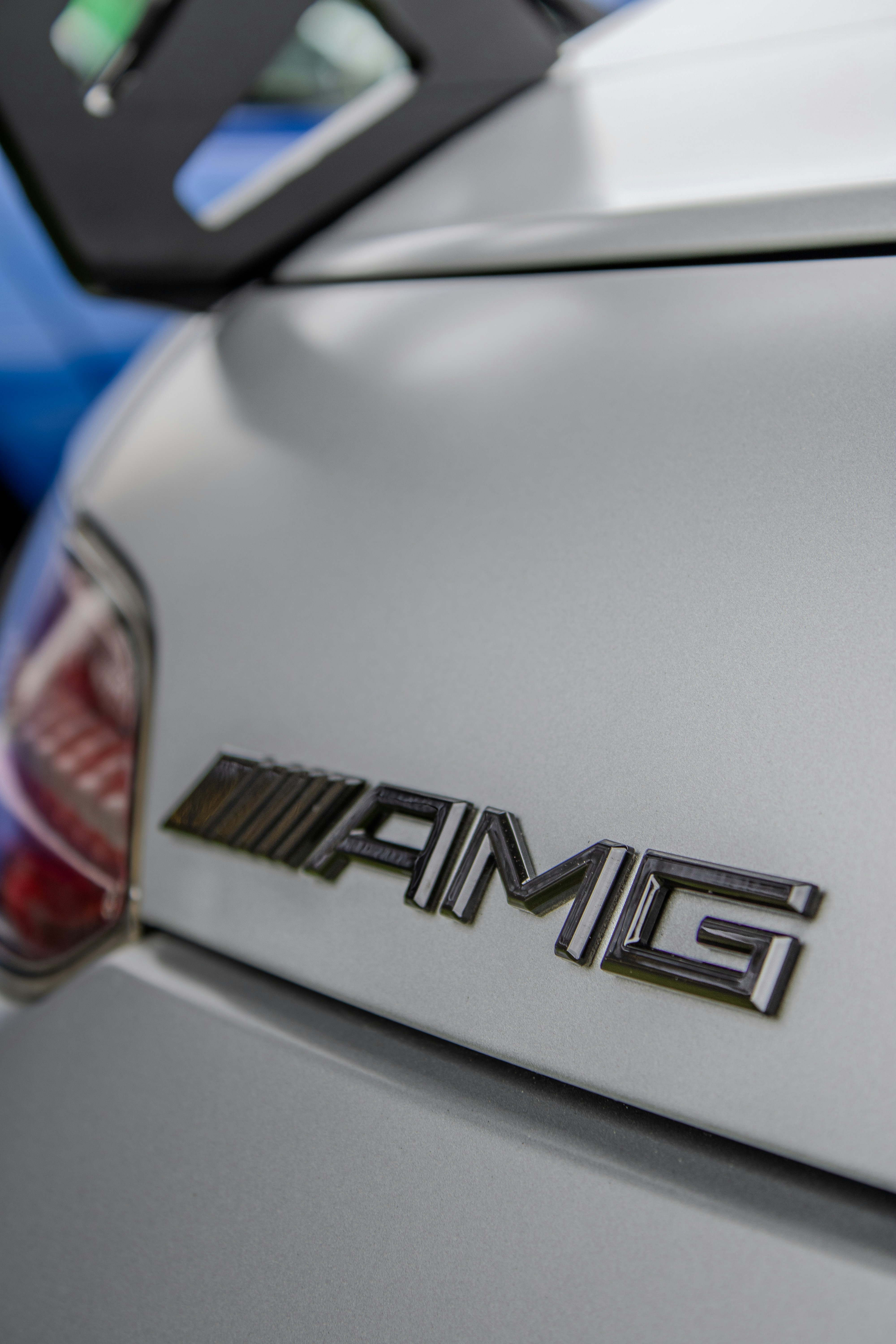 Emblem on Metallic Hood: AMG Badge Near Curved Silhouette