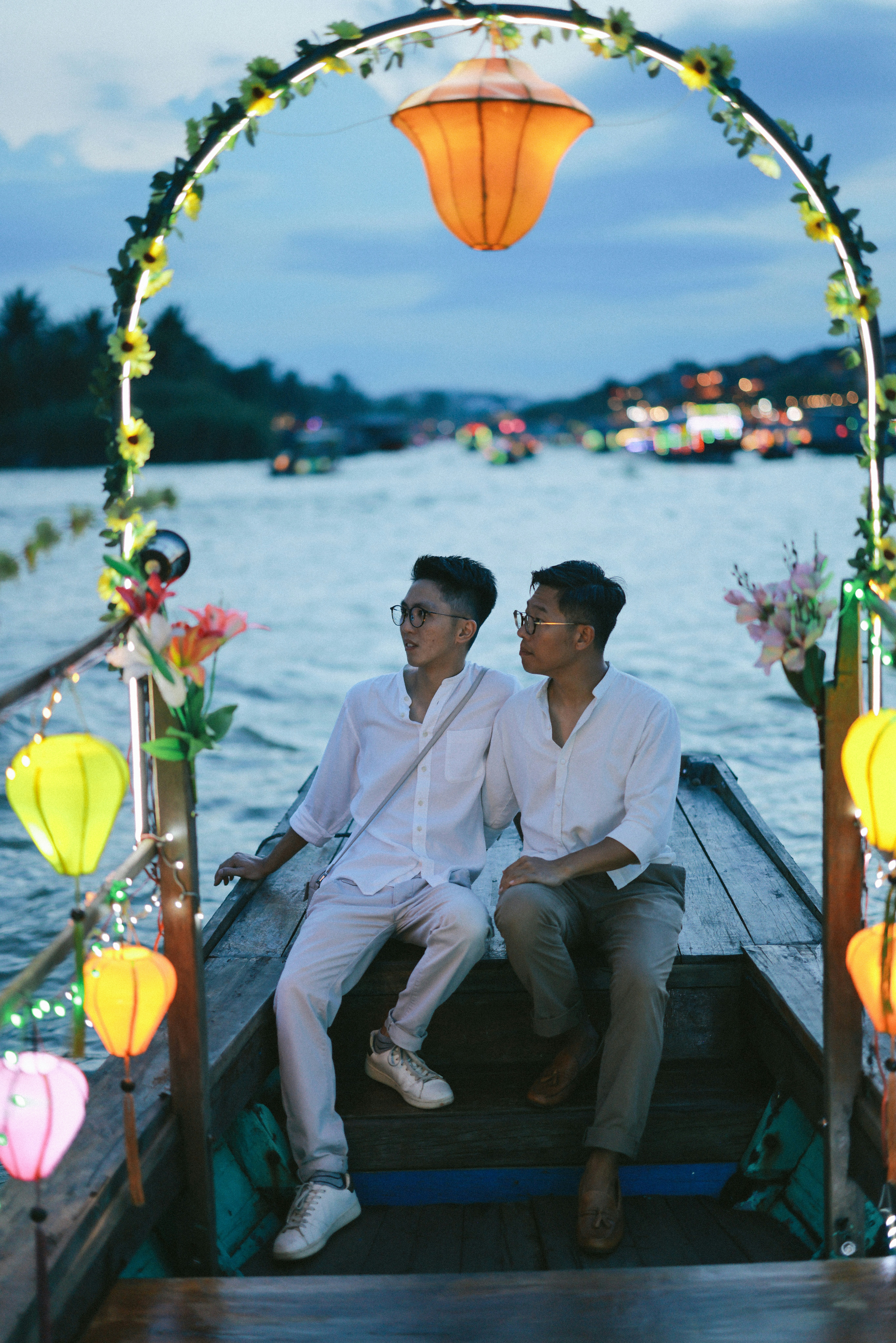 Two friends enjoy a boat ride at night.