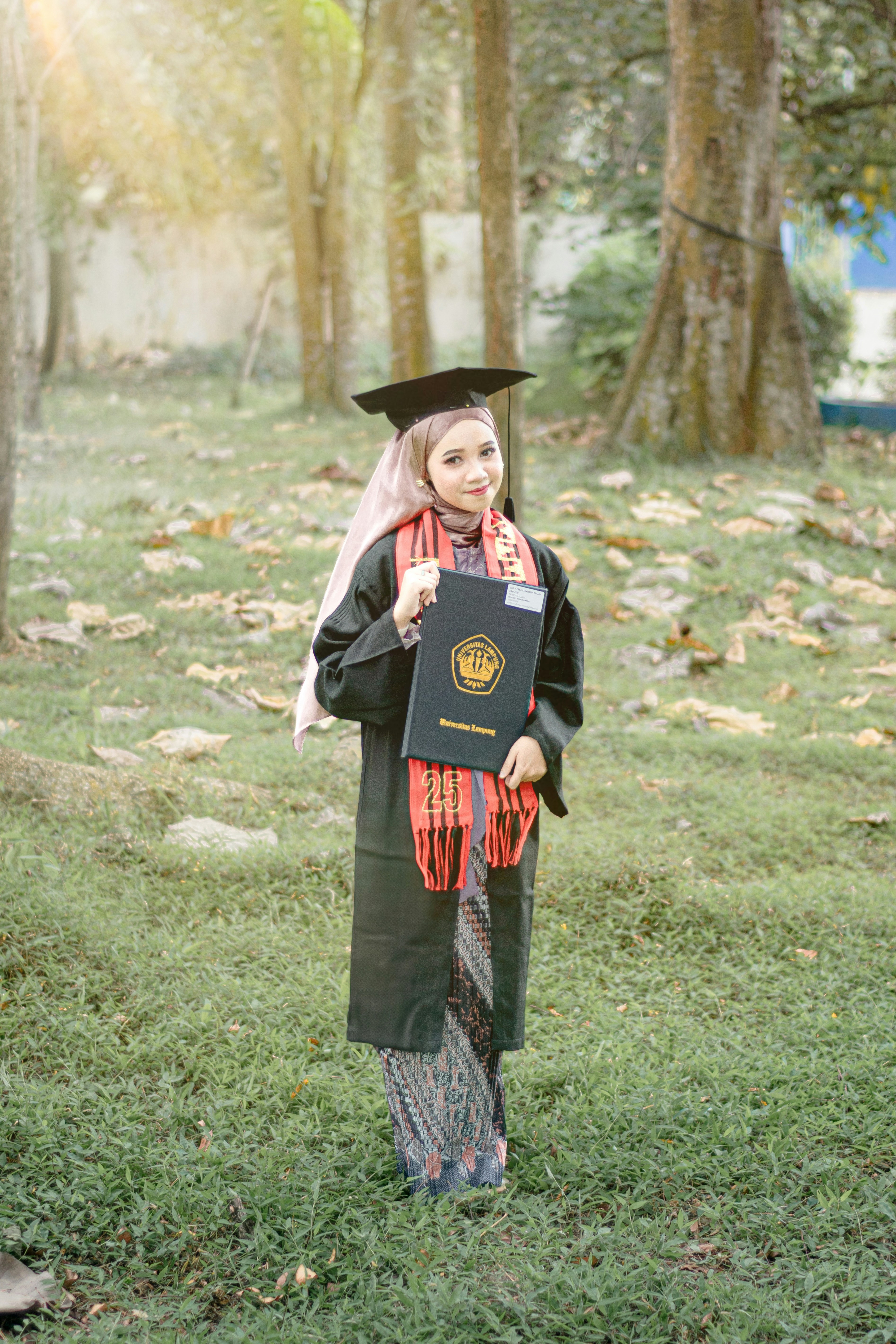A graduate celebrates her accomplishment with a diploma.