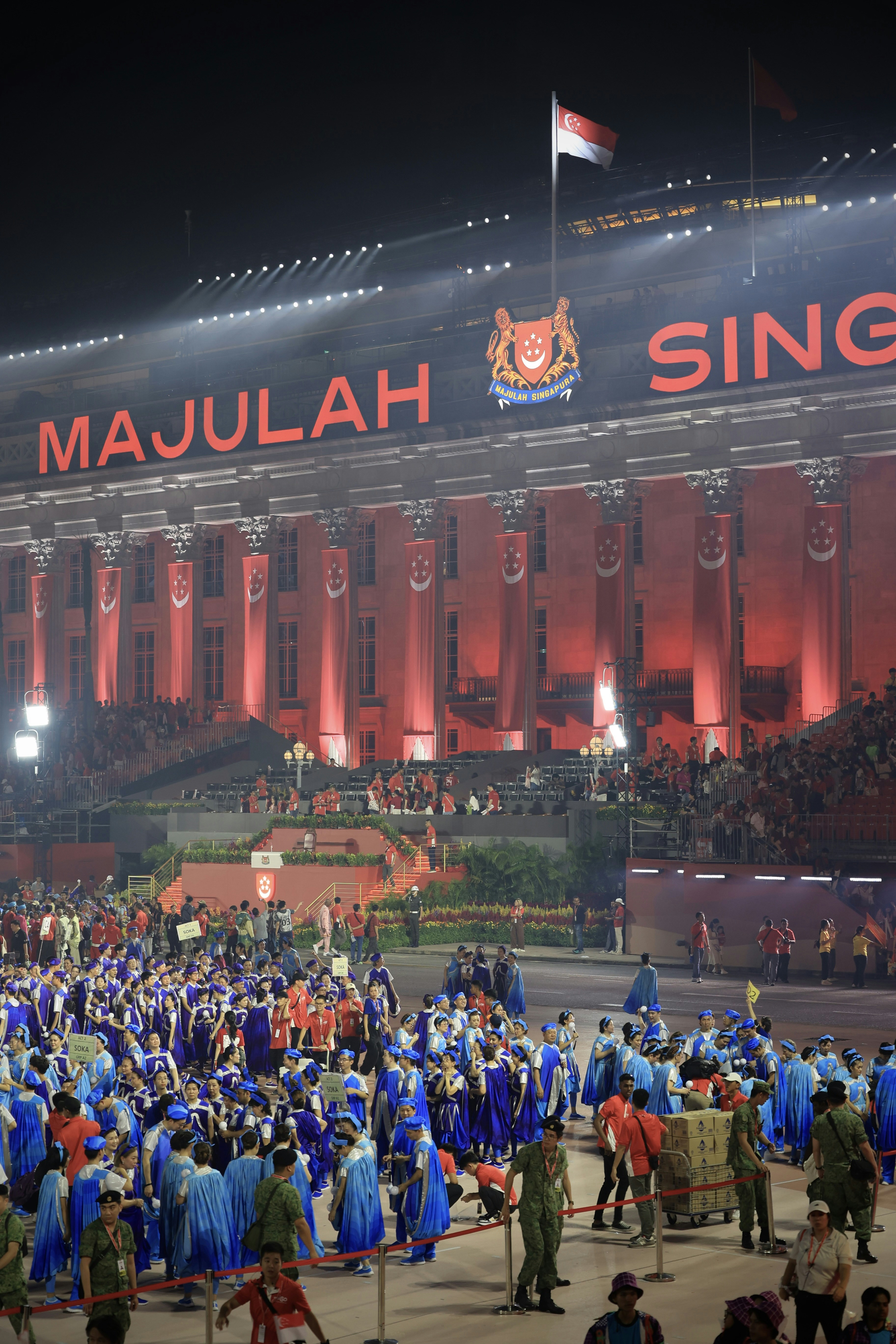 People marching in front of a building.