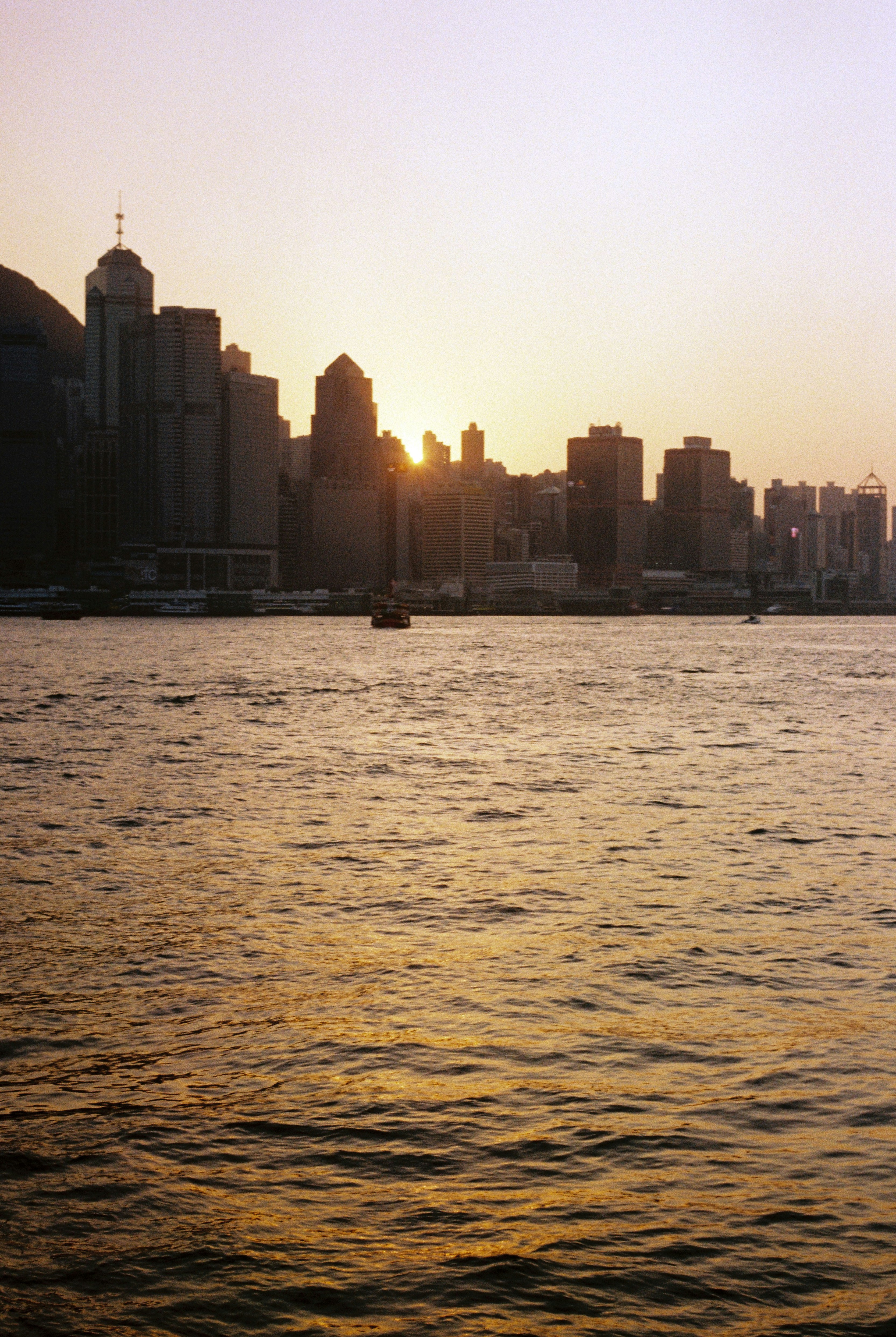 Sunset over the city skyline and water.