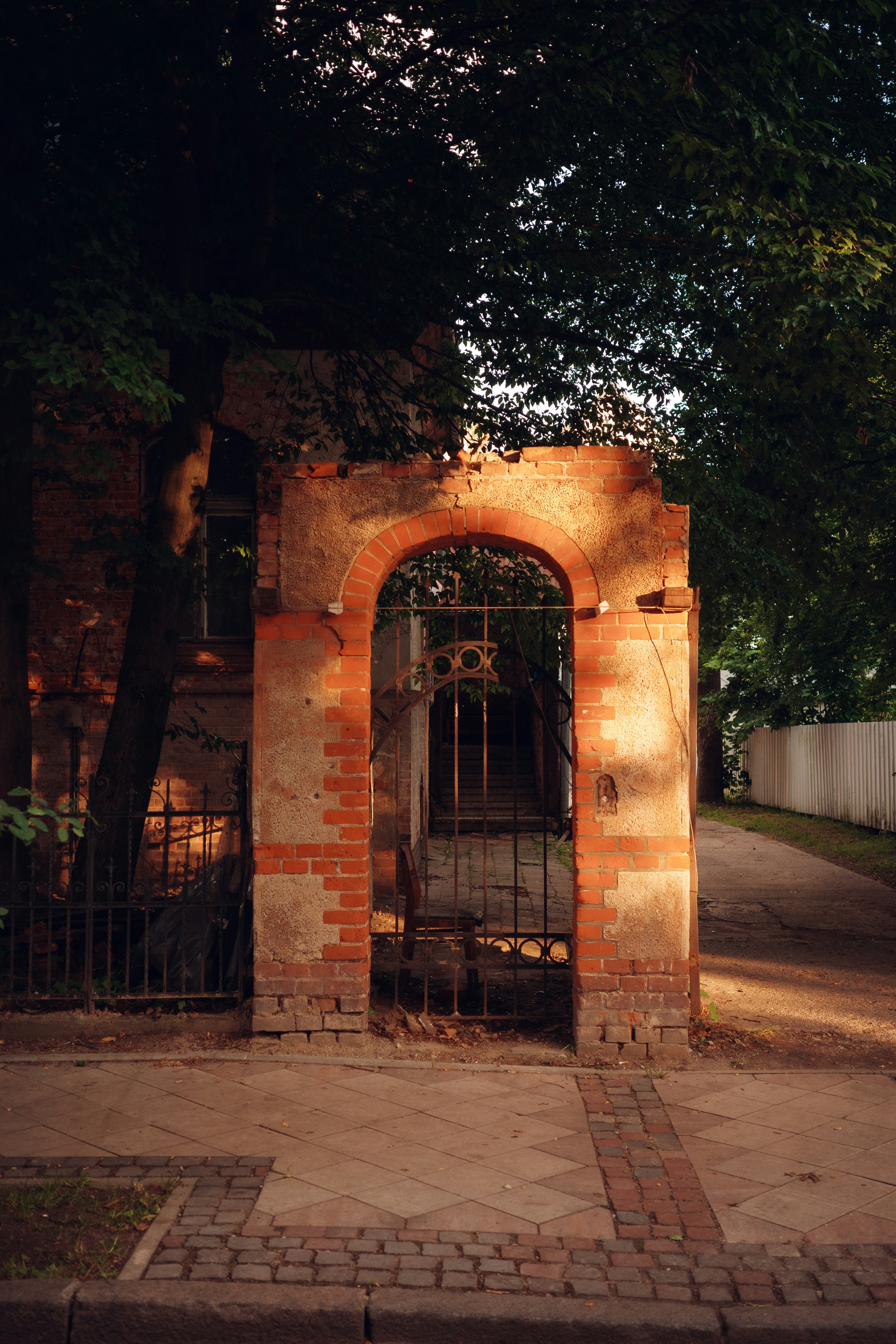 An old, brick archway opens into a dark interior.
