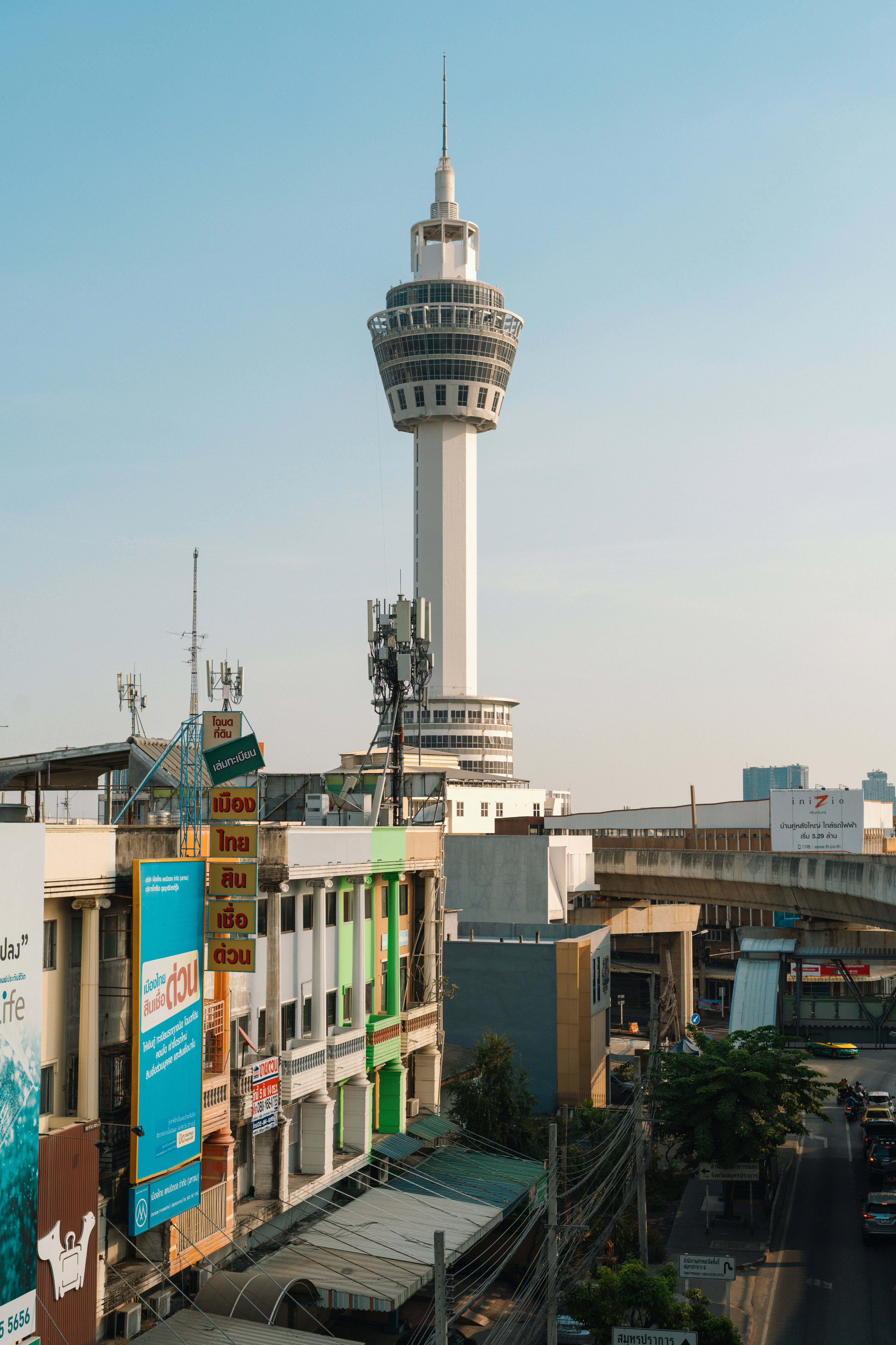 A tall observation tower rises above buildings. photo – Free Travel ...