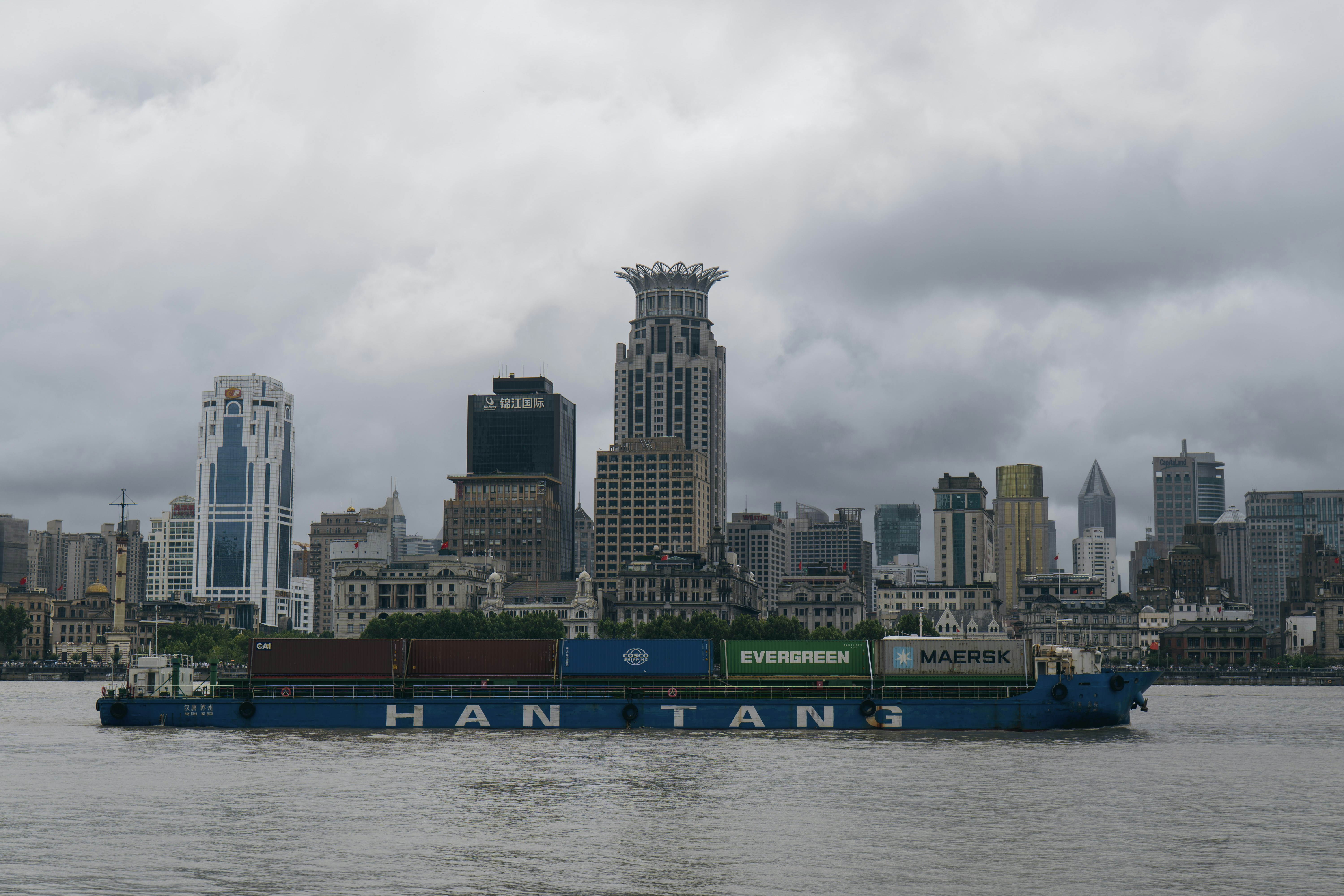 Urban Harmony: A Cargo Ship's Journey Through Shanghai's Skyline