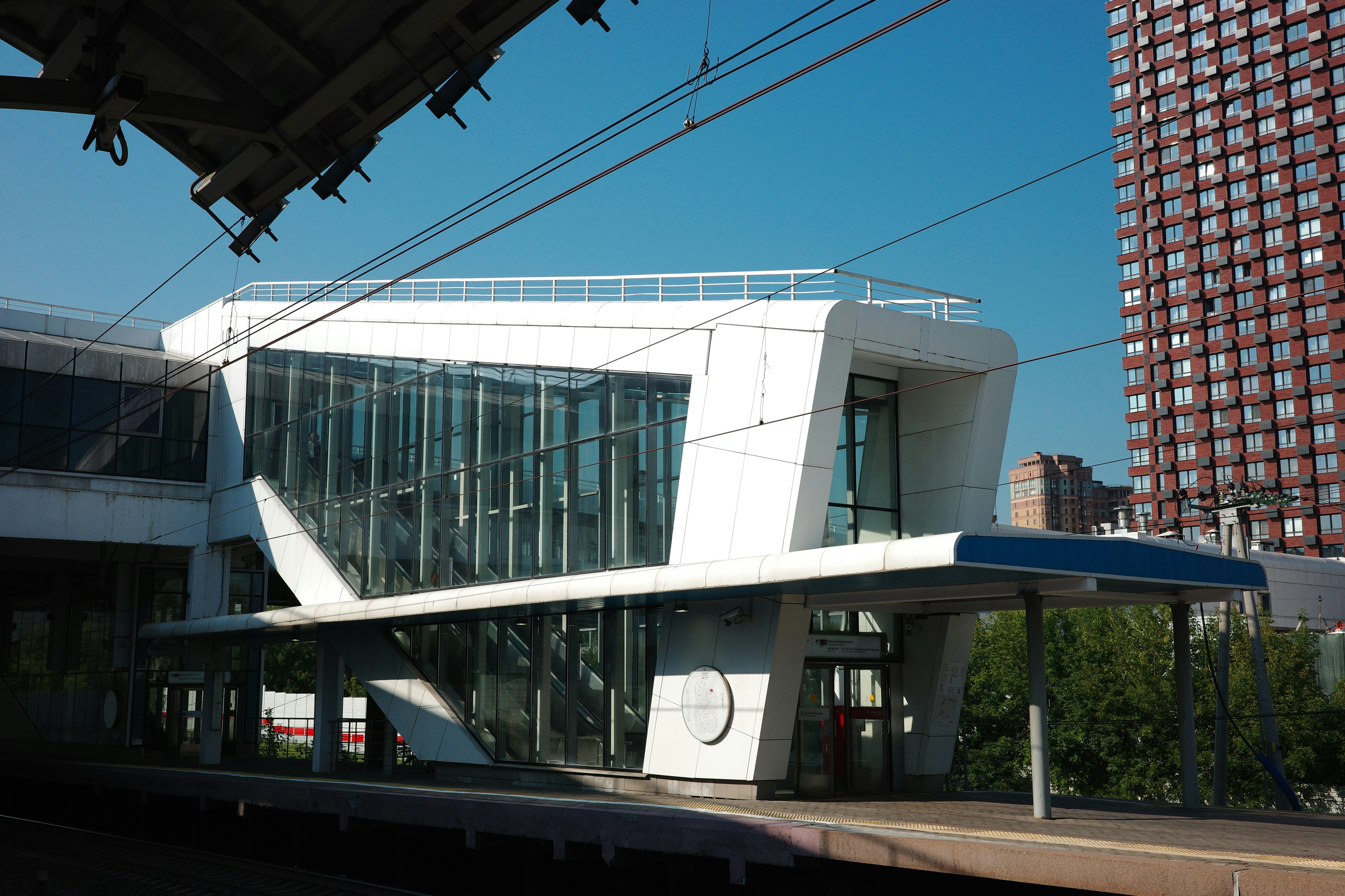 Modern train station building under a clear blue sky.