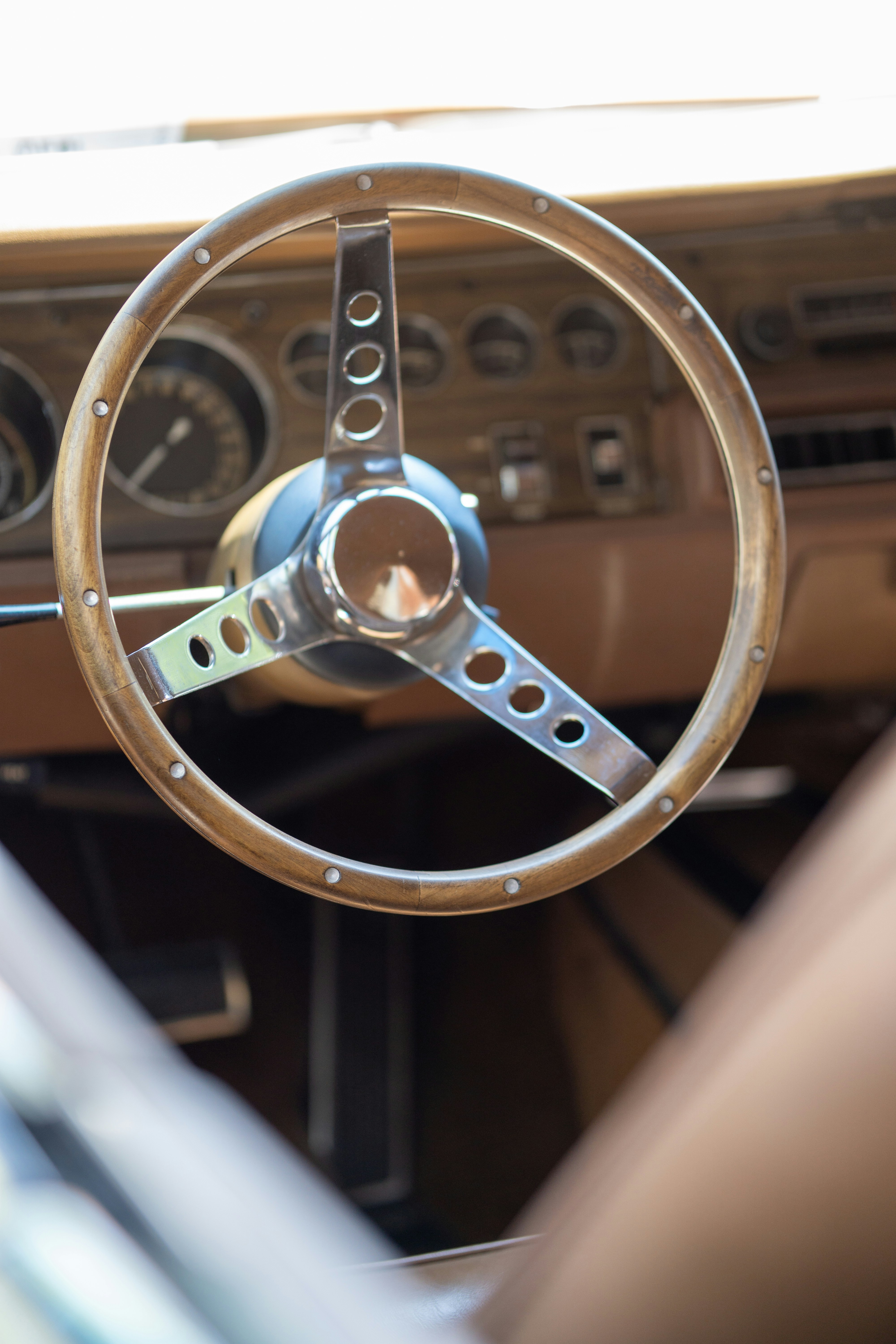 A vintage car's steering wheel is shown.