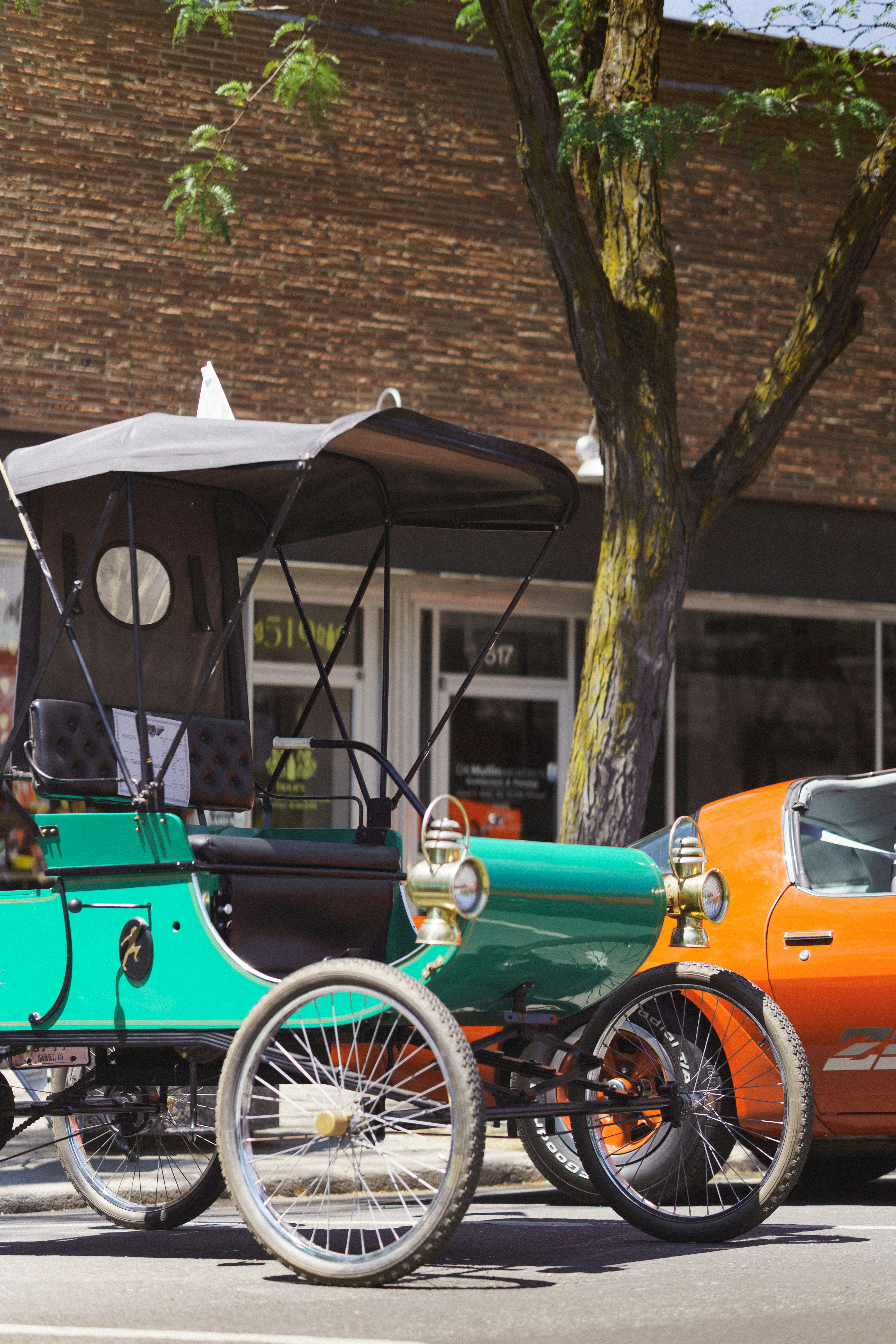 Vintage Carriage in Focus: an Urban Street Scene with Colorful Autos