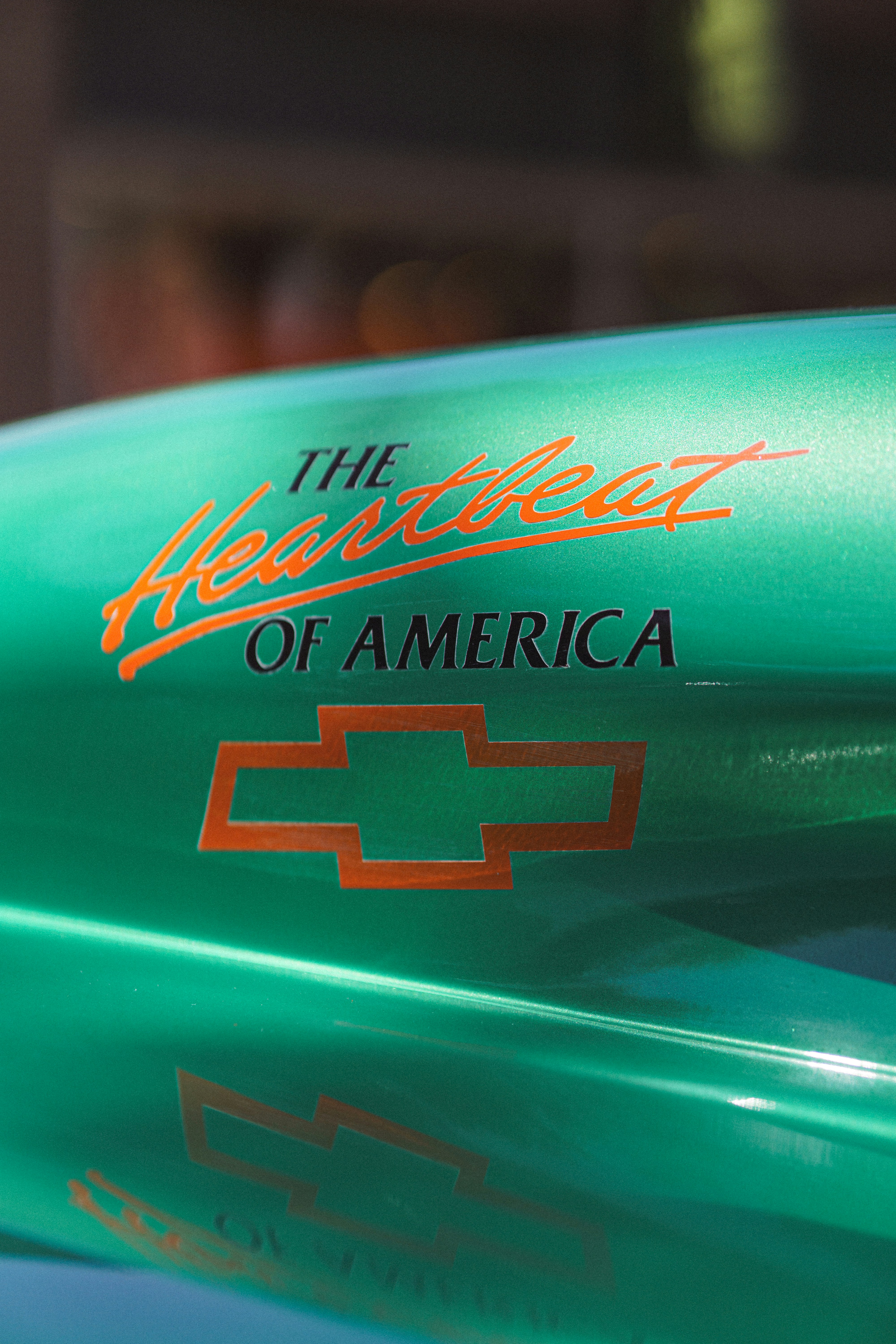 Chevrolet logo and slogan 'The Heartbeat of America' displayed on a vibrant green surface.