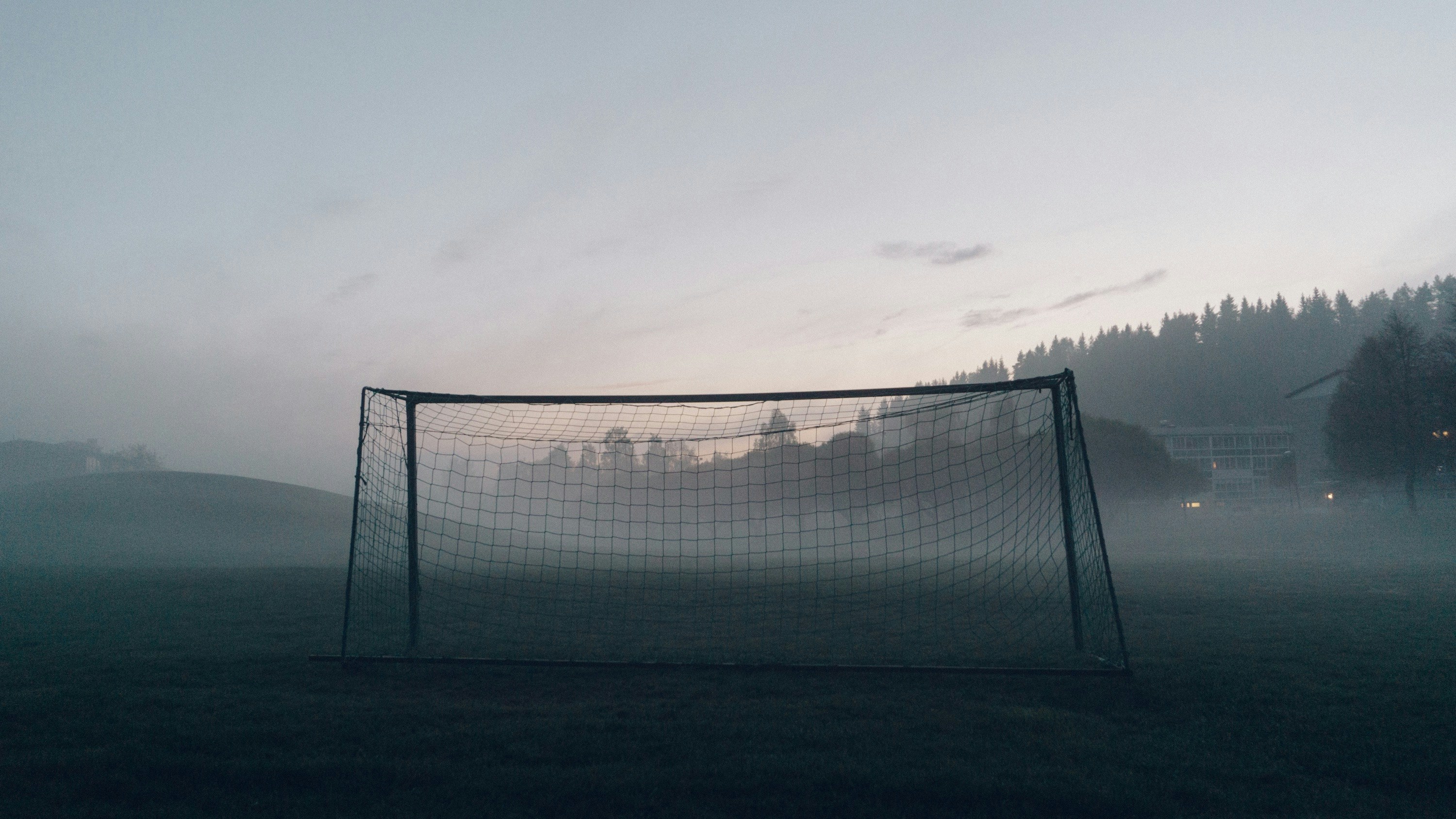 A soccer goal stands silent in a misty field. photo – Free Field Image ...