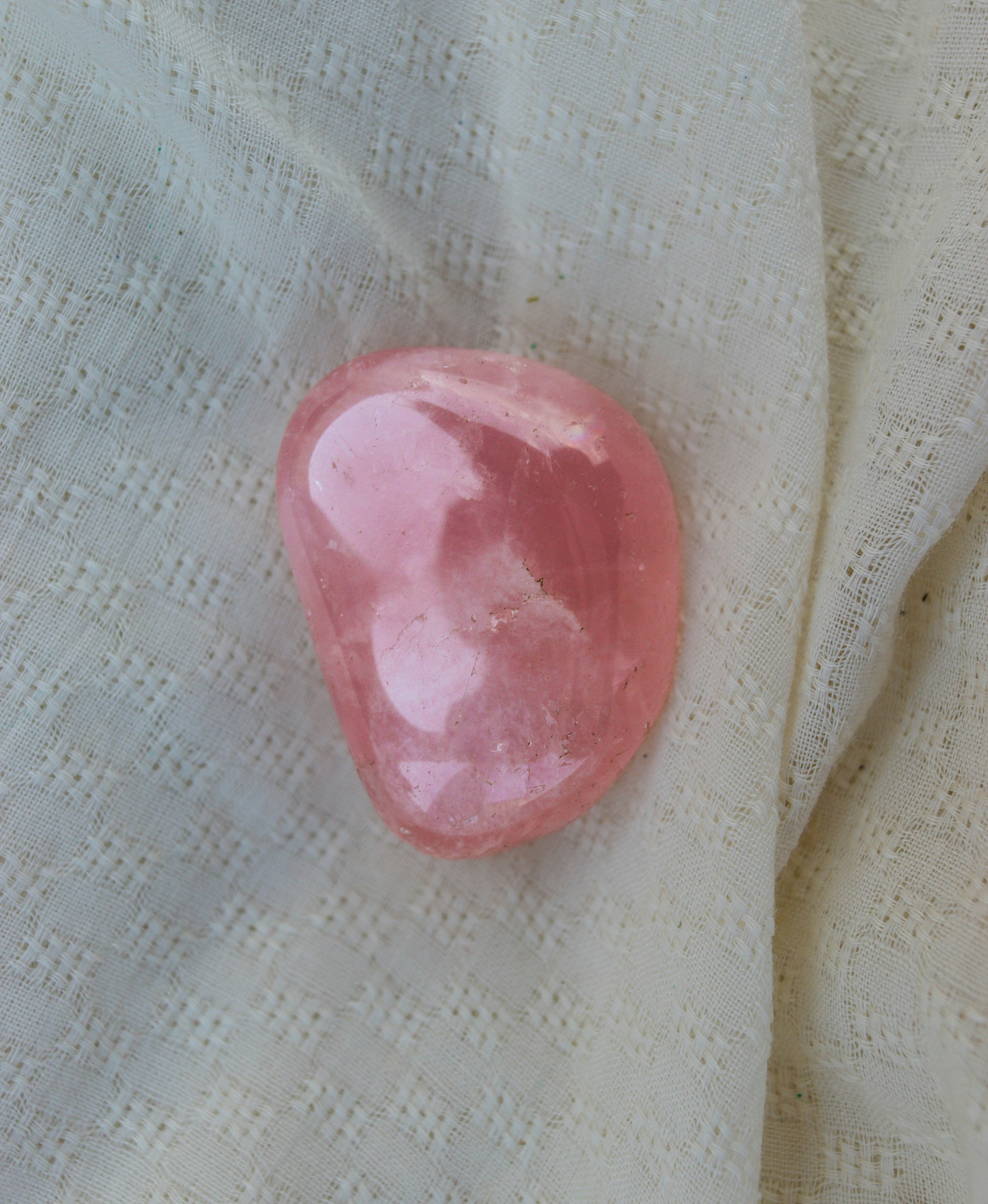 A smooth, pink rose quartz gemstone.
