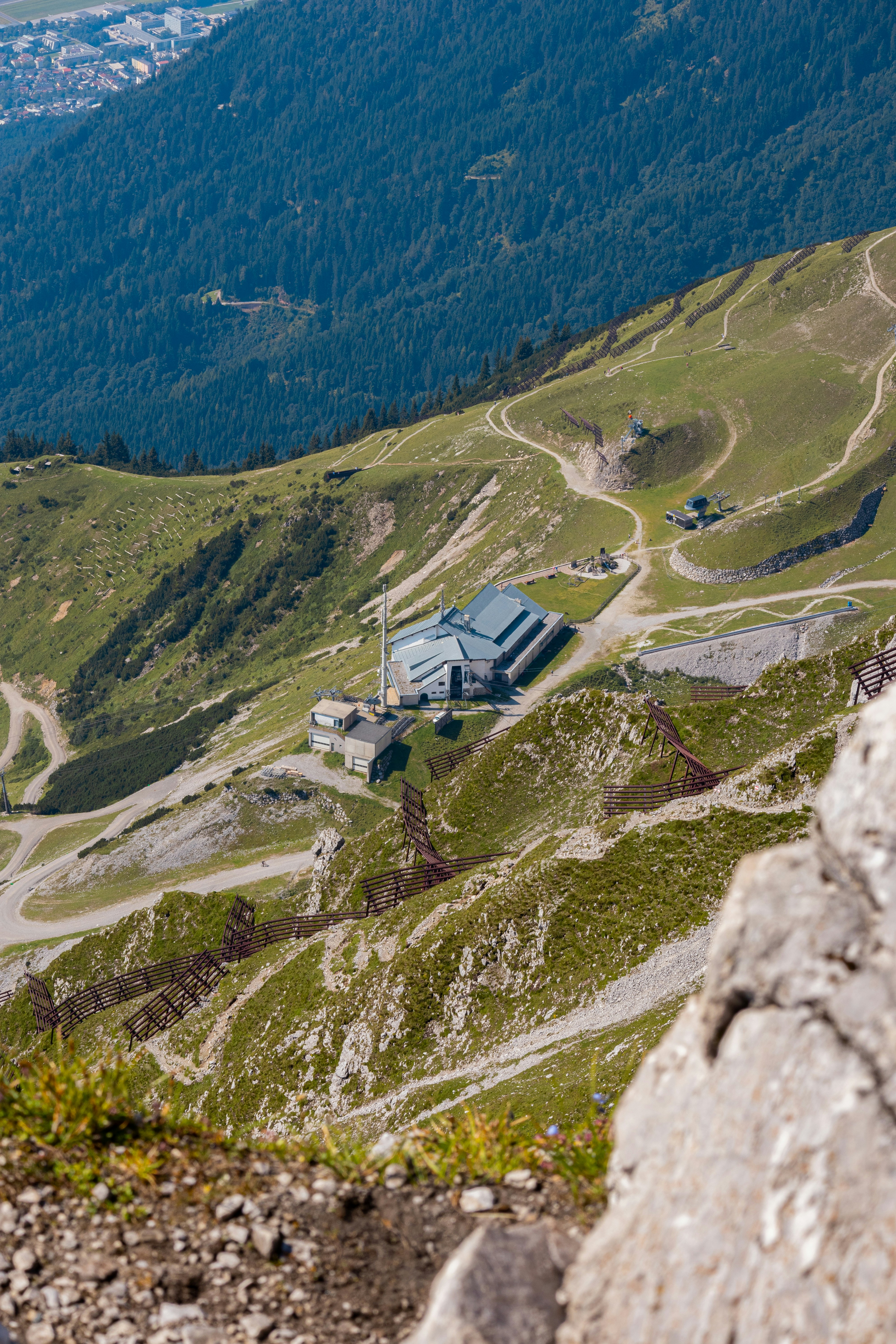 Mountain buildings and a town are visible below.