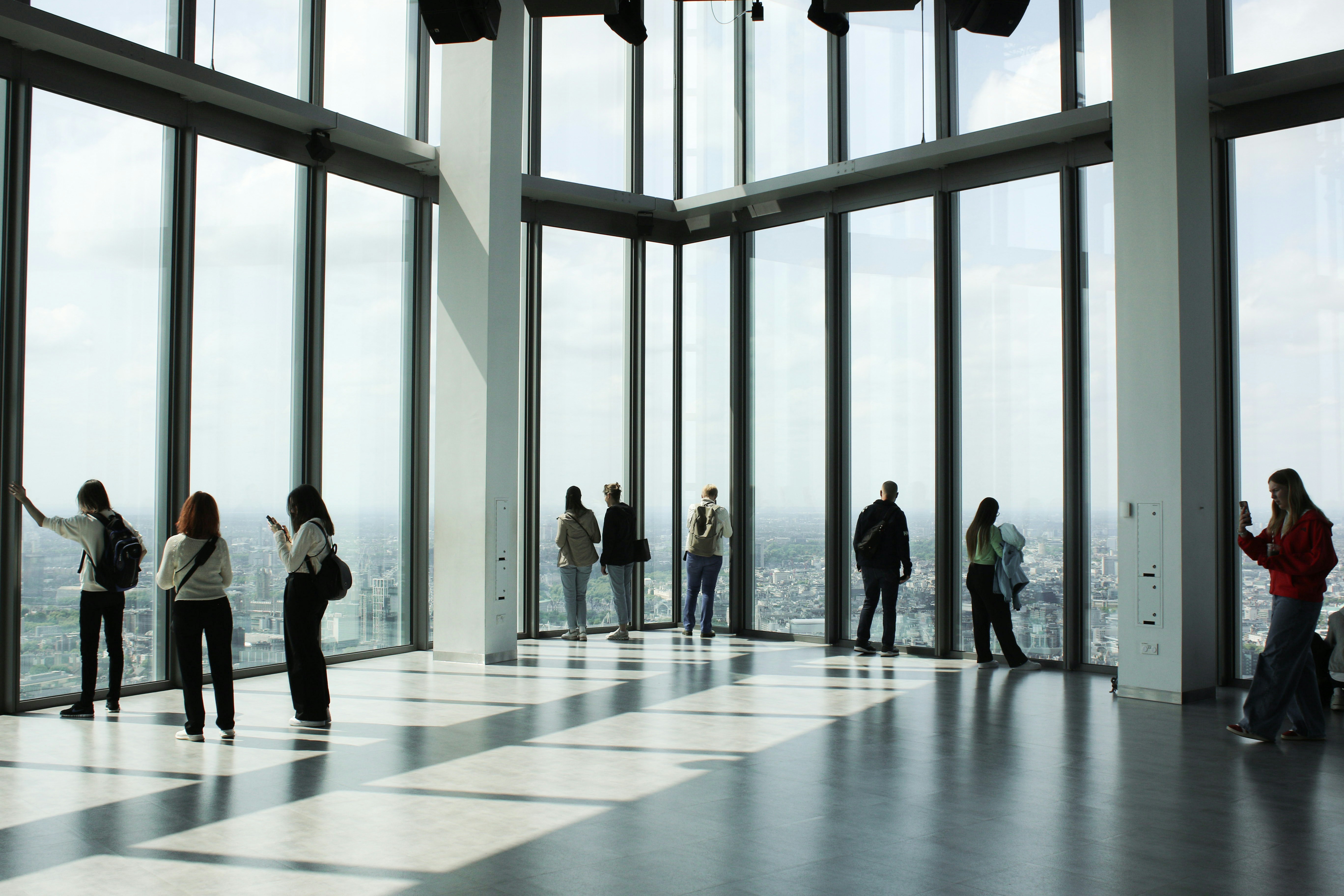 People admire the view from a tall building.