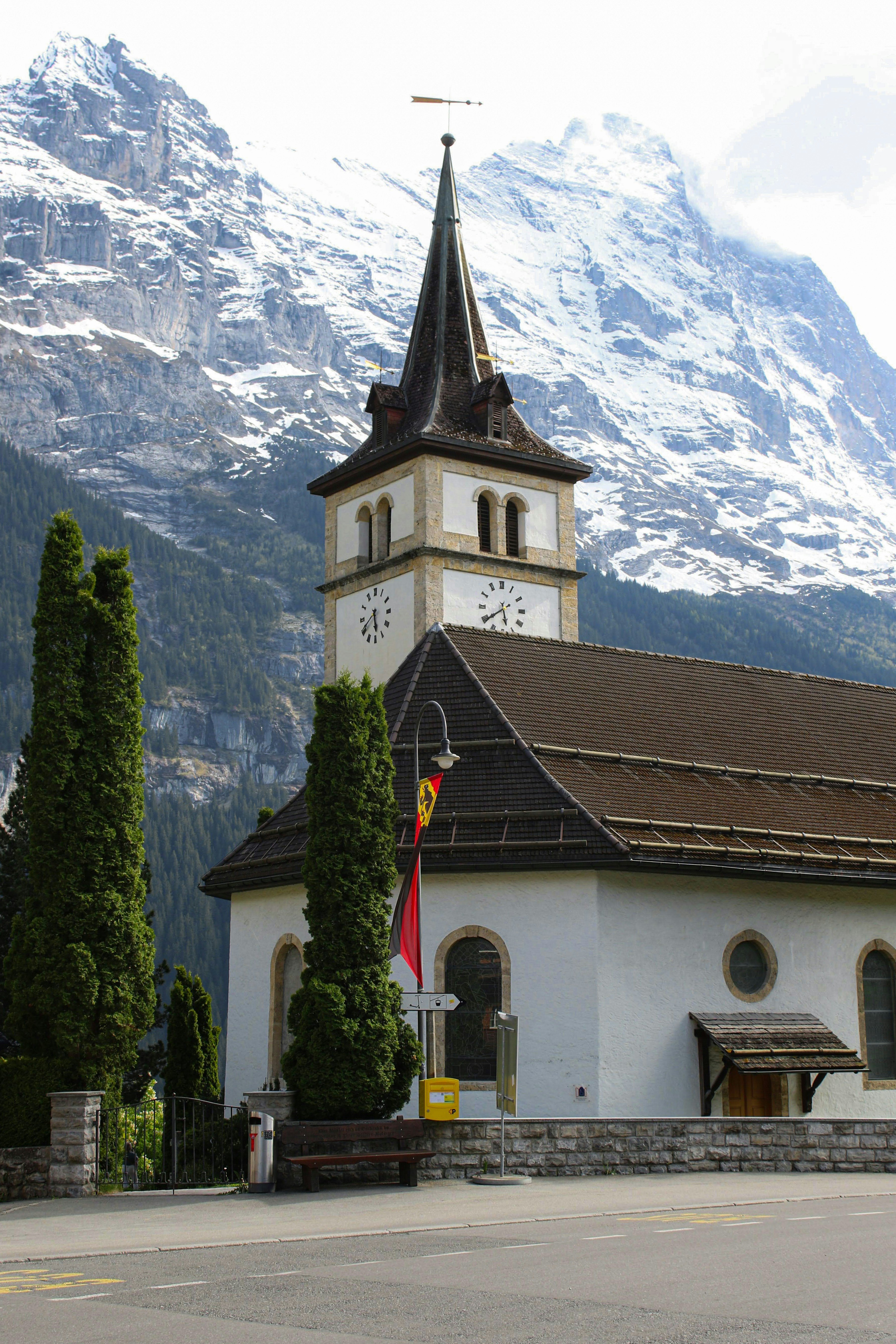 Church nestled with snowy mountains in the background.