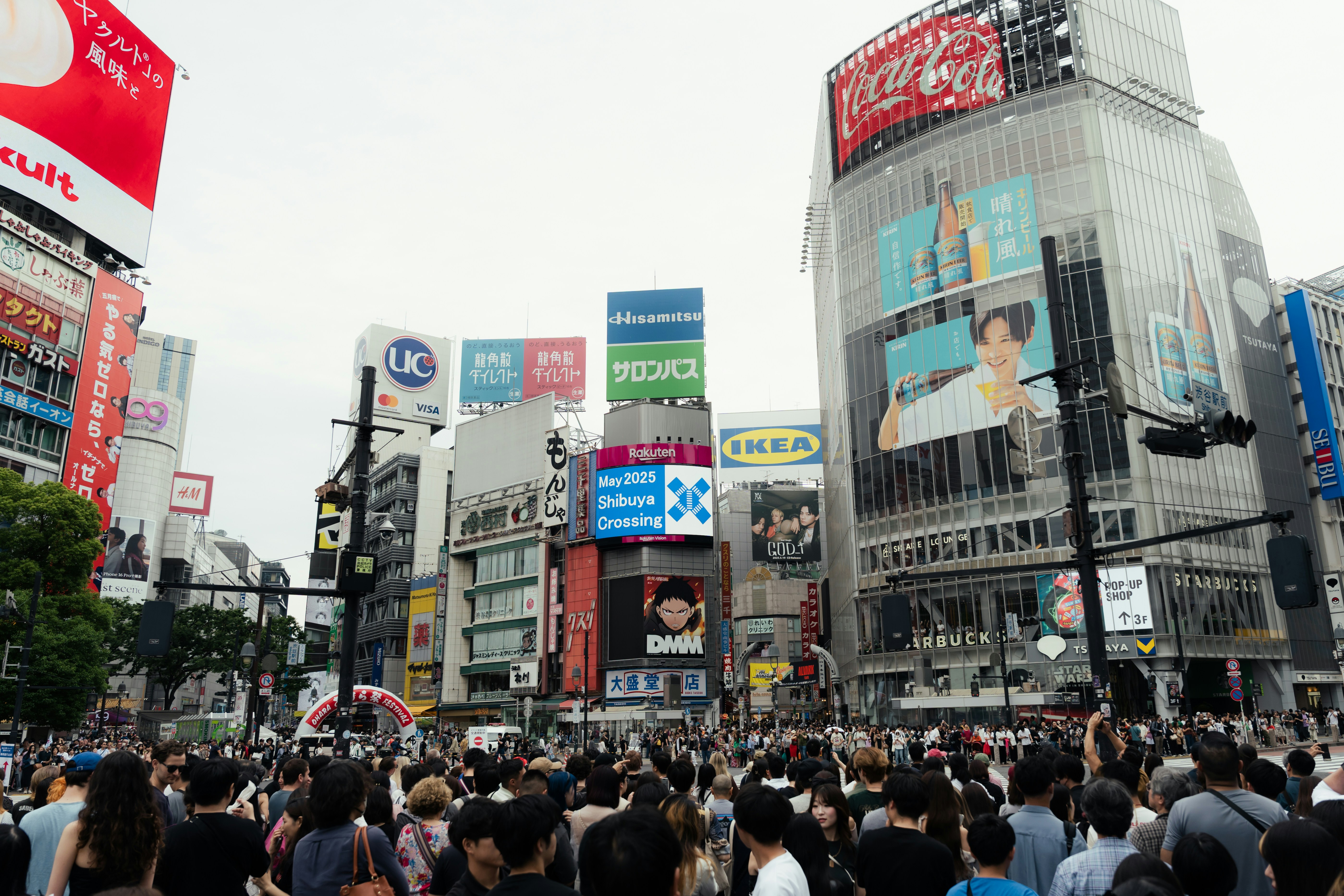 Busy shibuya crossing filled with many people.