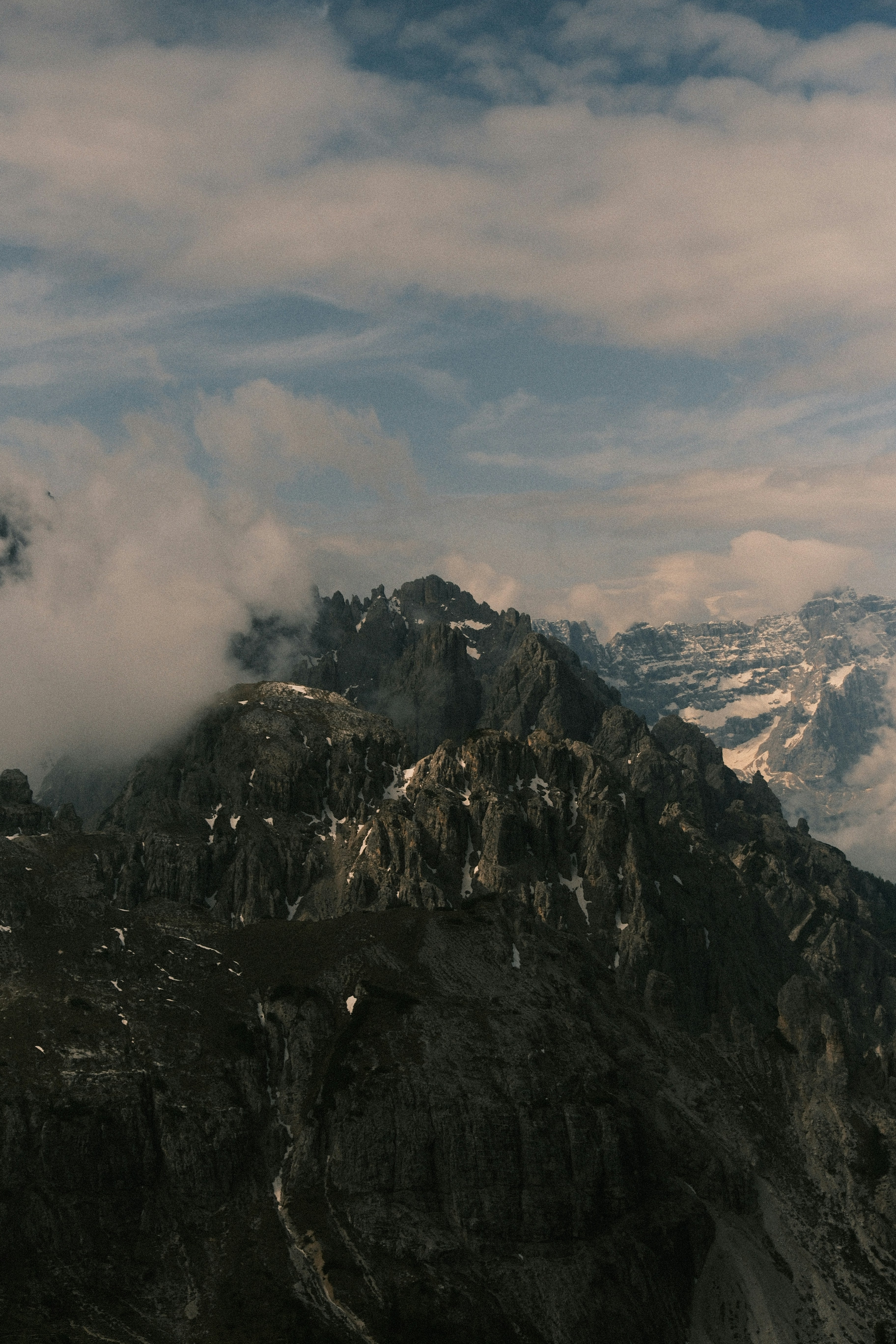 Mountains peek through the clouds.