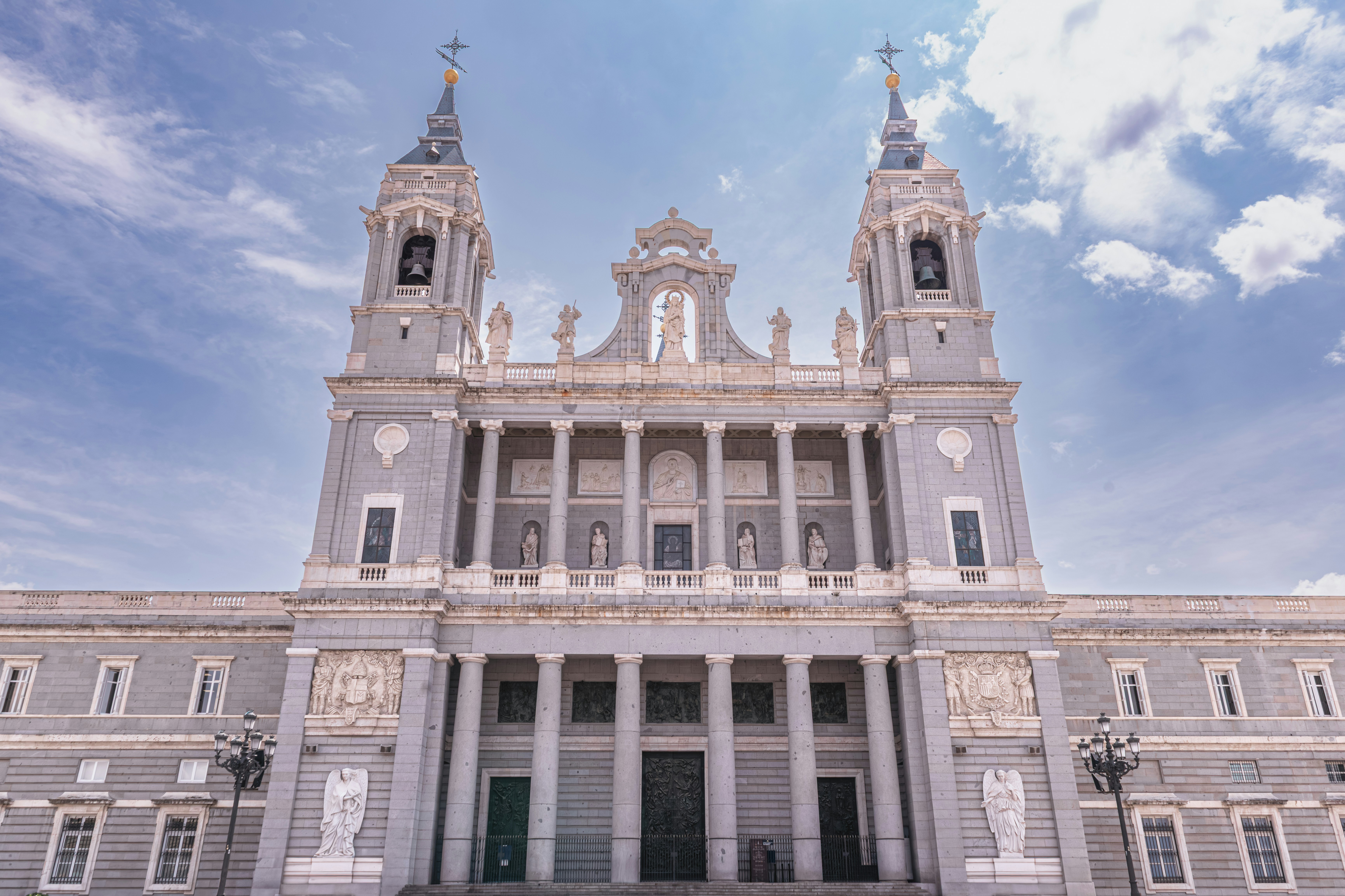 A majestic, gray cathedral stands tall under the blue sky.