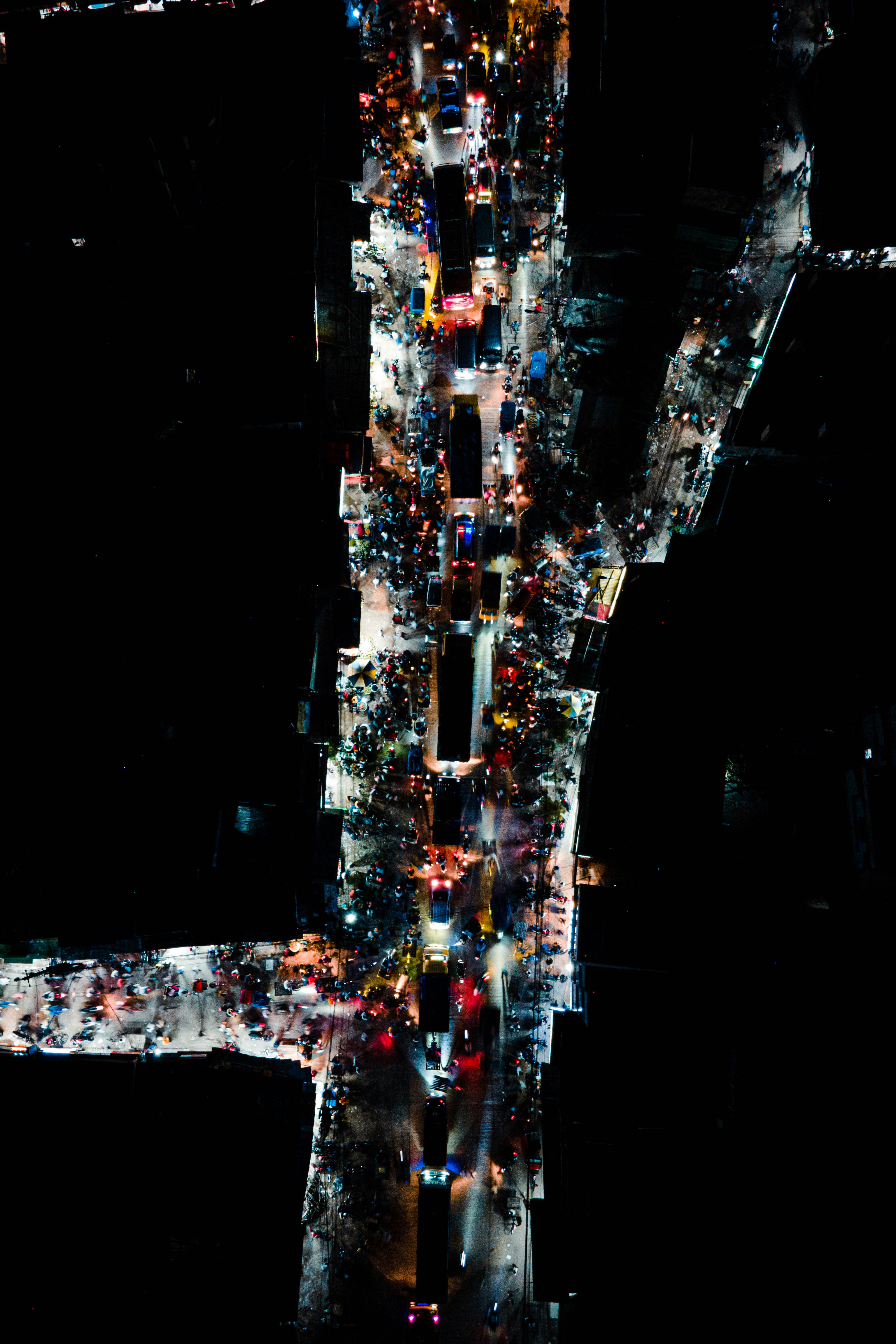 Aerial View of Nighttime Traffic in Urban Bangladesh | Aerial view of a busy, illuminated street at night.