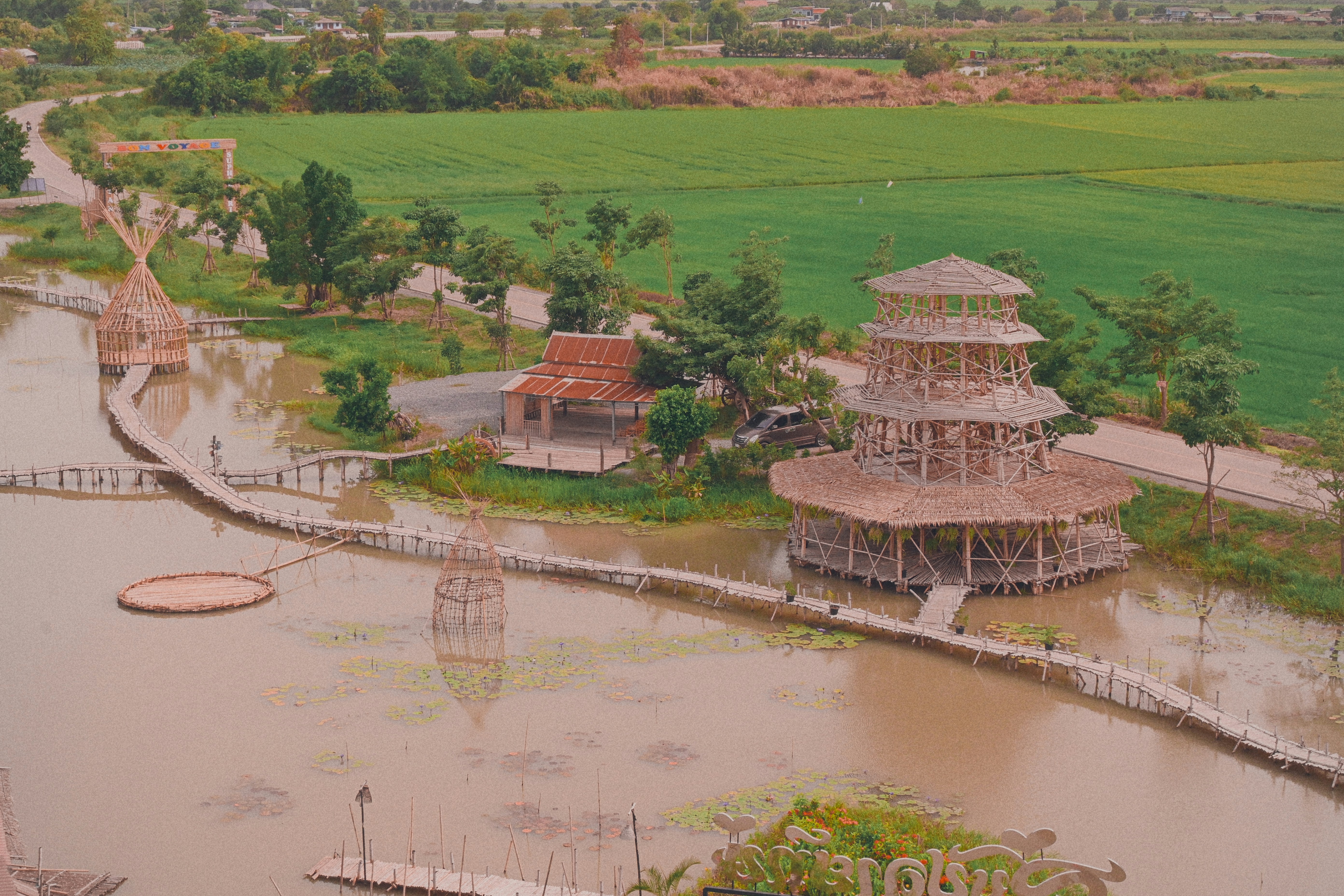 Wooden structures are surrounded by water and greenery.