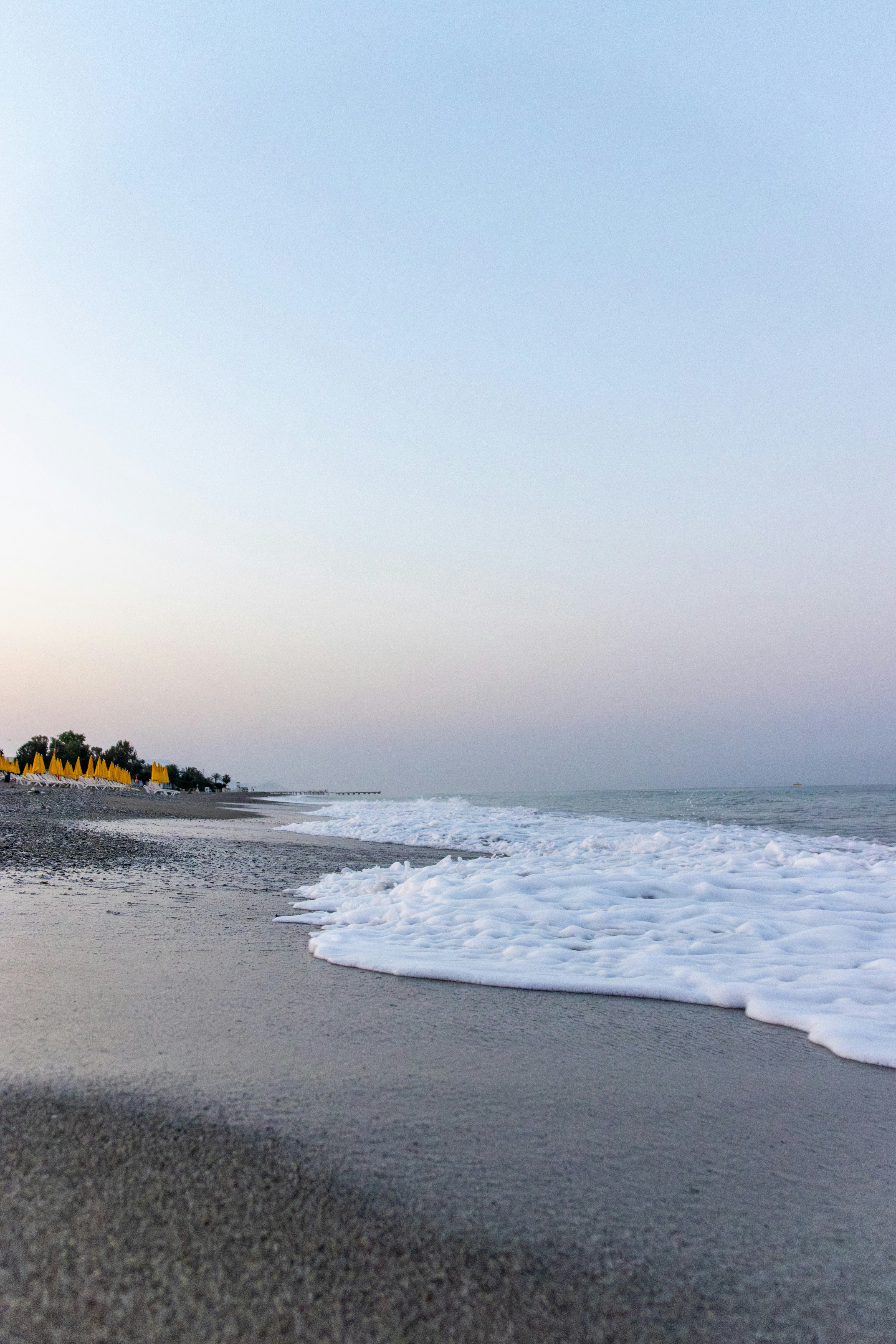 Twilight Row of Yellow Tents Along a Quiet Seaside