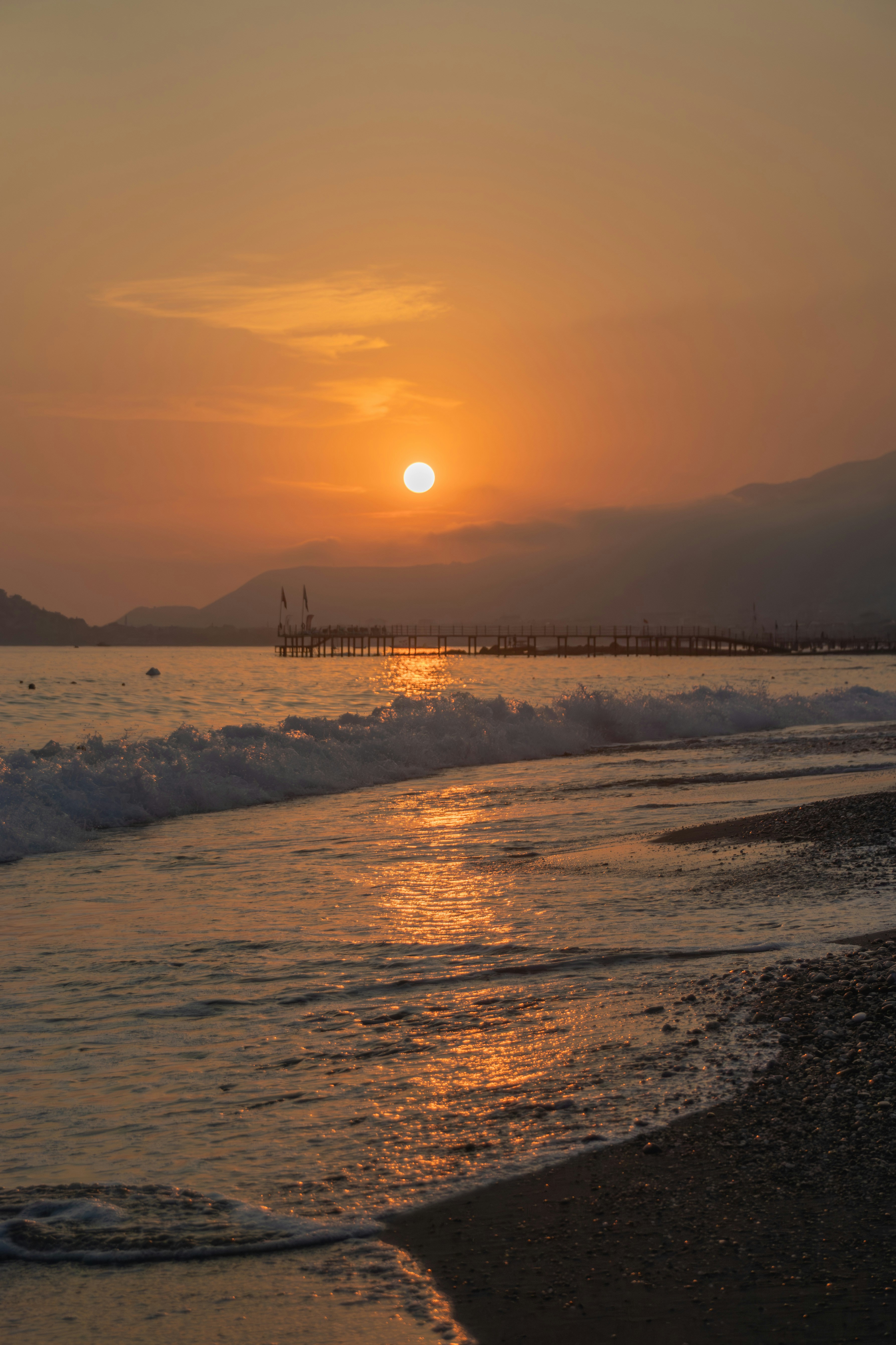 Sunset beach | Sunset over the ocean creating a beautiful scene.