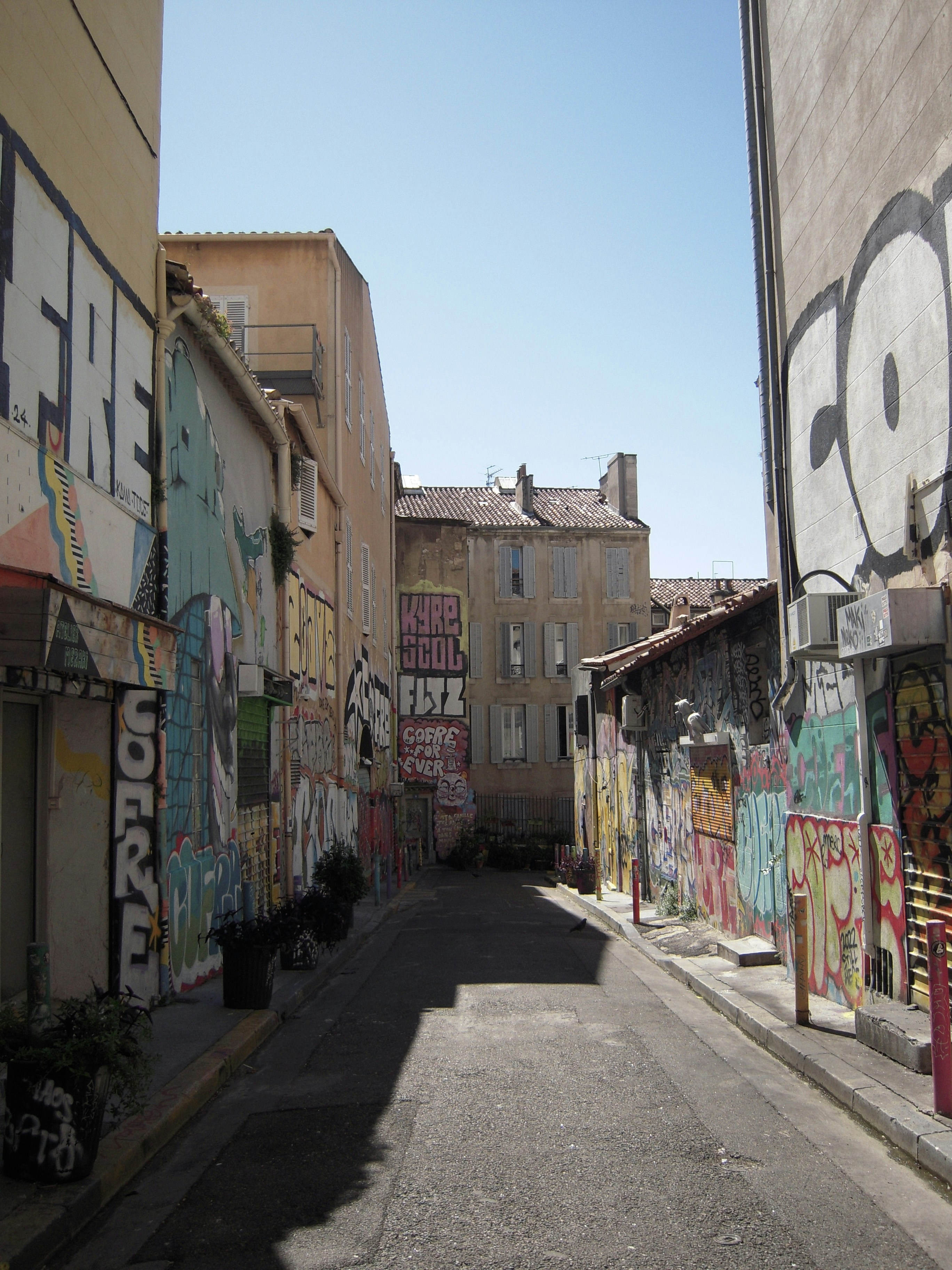 Alleyway with colorful graffiti covering the walls.