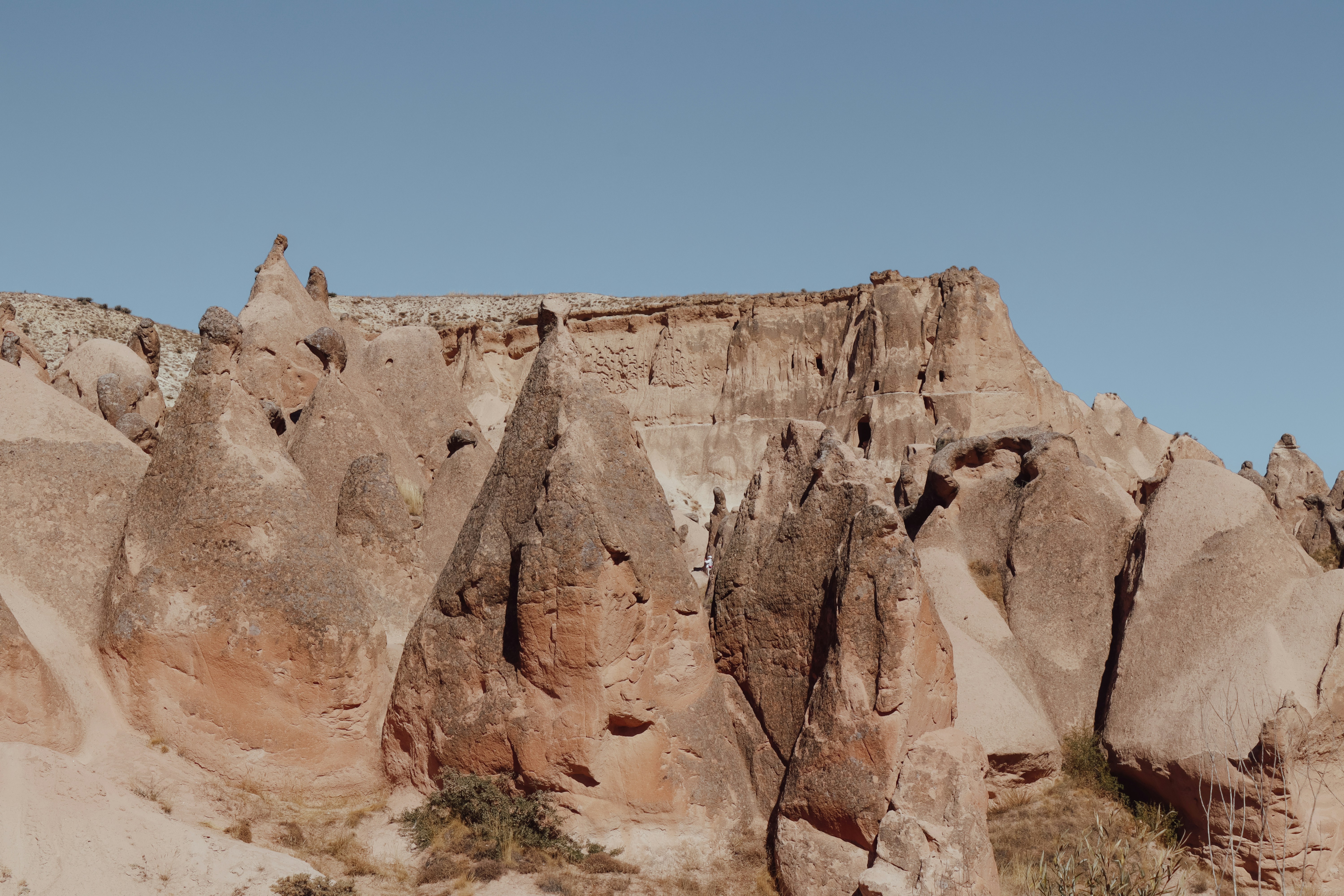 Stunning Fairy Chimneys in Cappadocia, Türkiye | Eroded rock formations under a clear, blue sky.