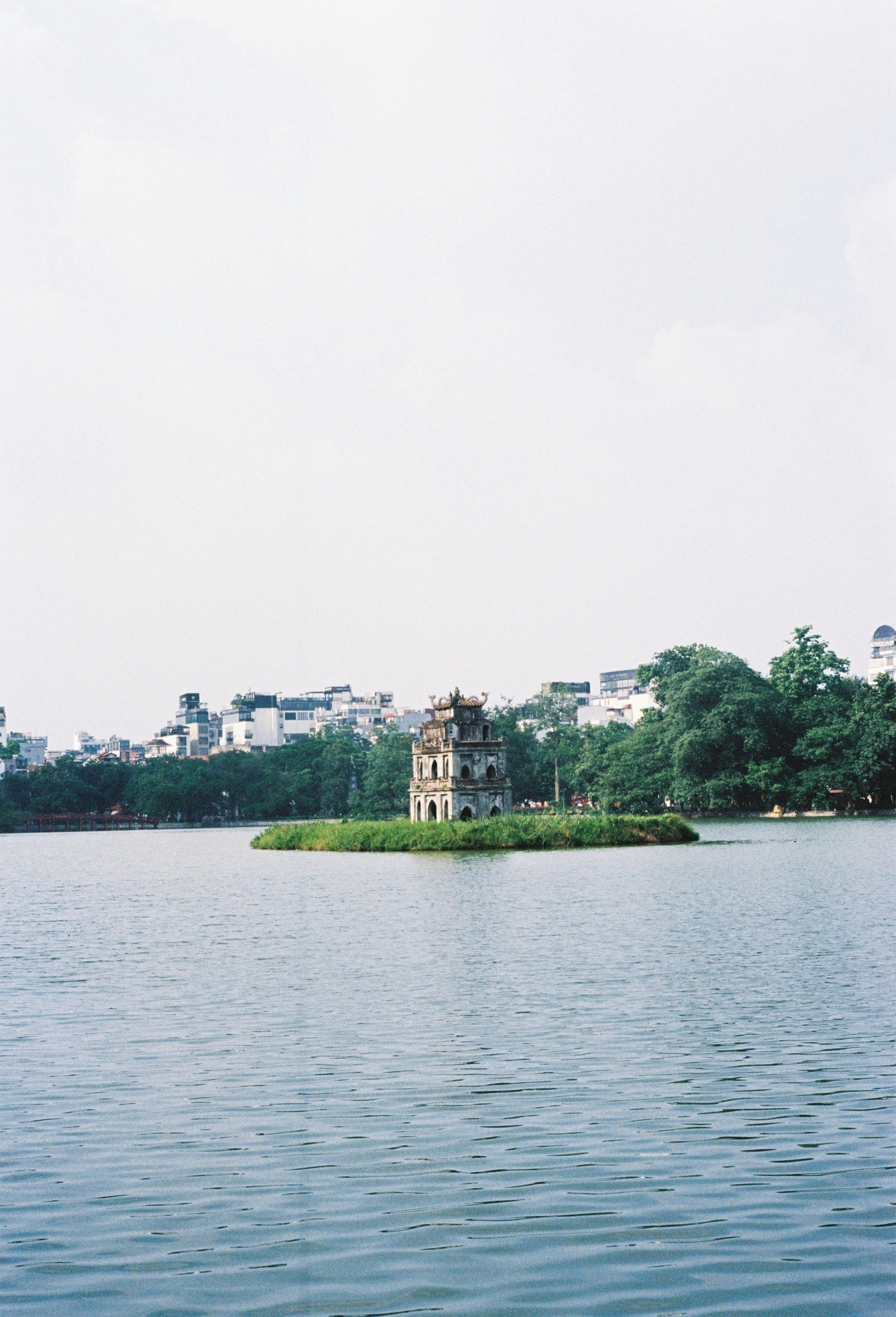 A tower stands on a lake's tiny island.