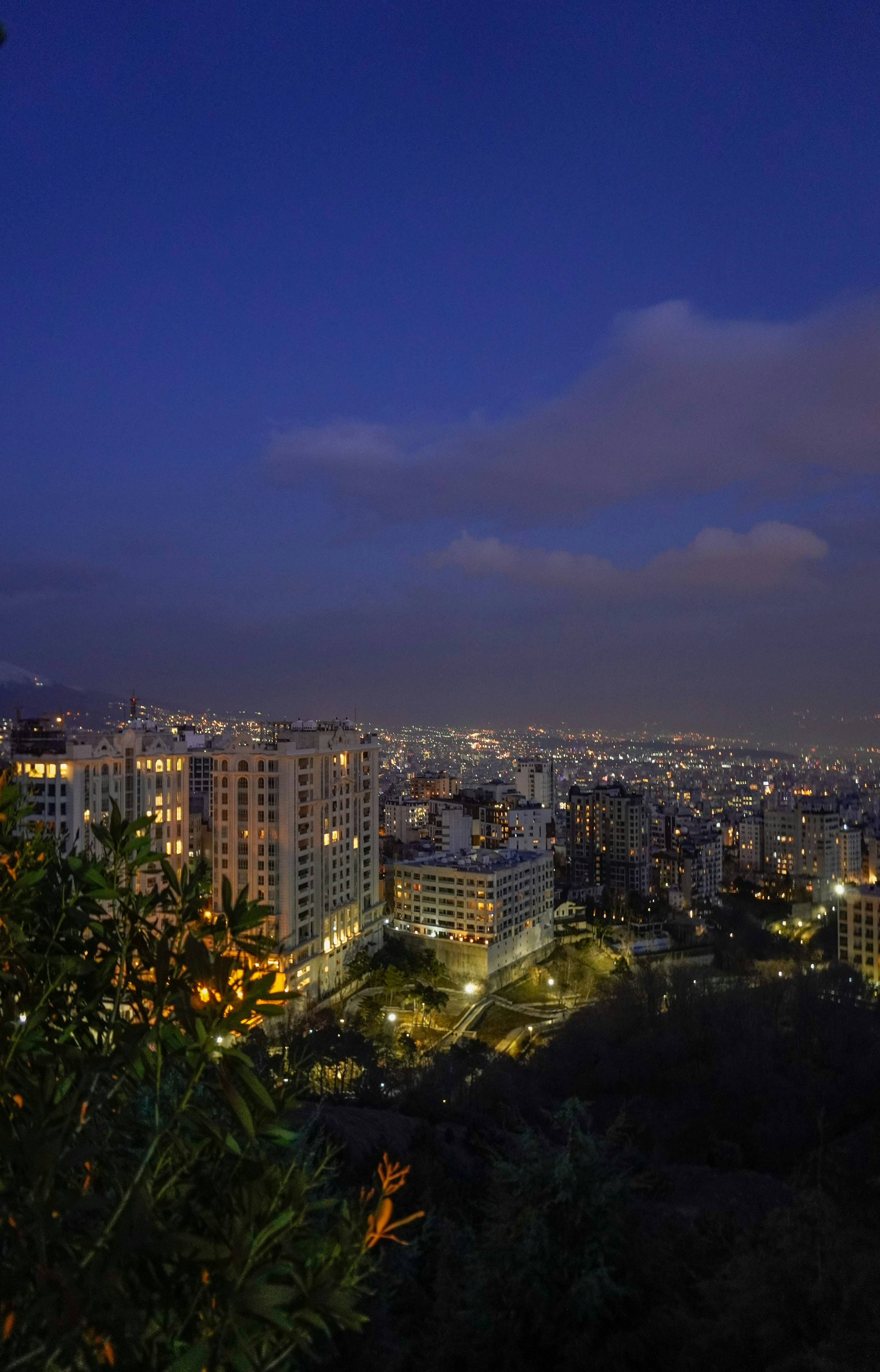 City lights illuminate a night sky.