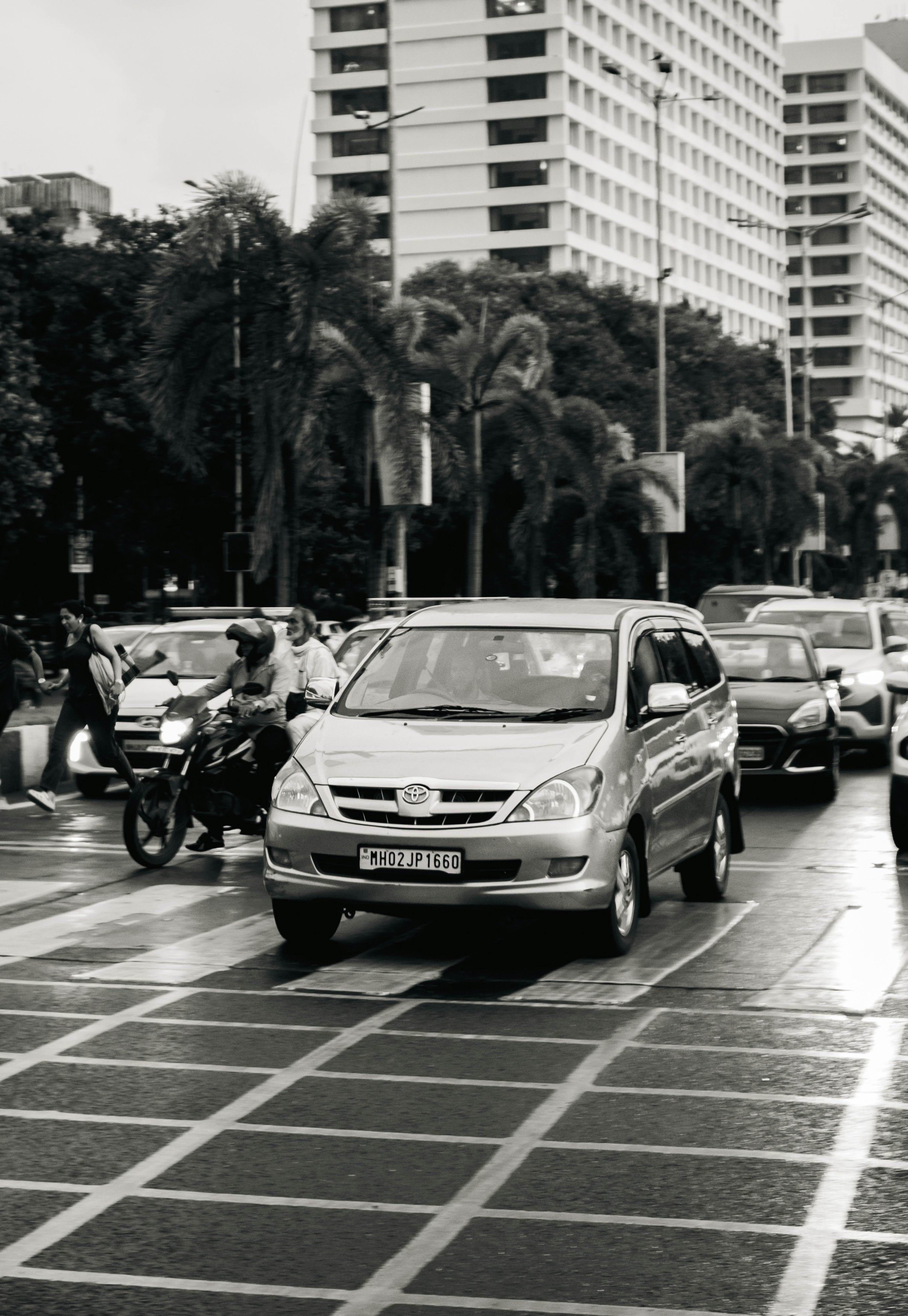 Cars and a motorcycle navigate a city intersection. photo – Free Car ...